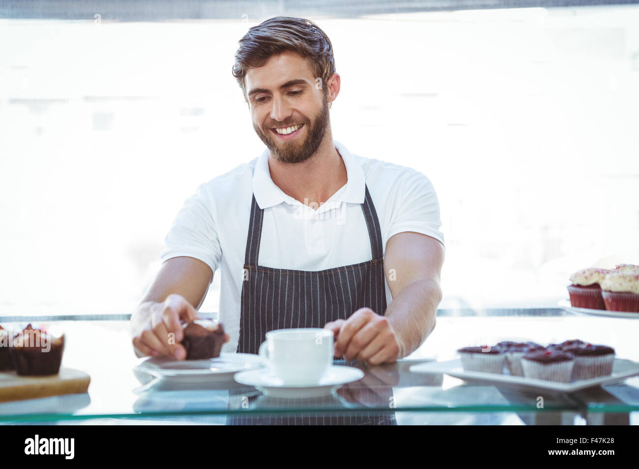 Smiling worker prepares breakfast Stock Photo - Alamy