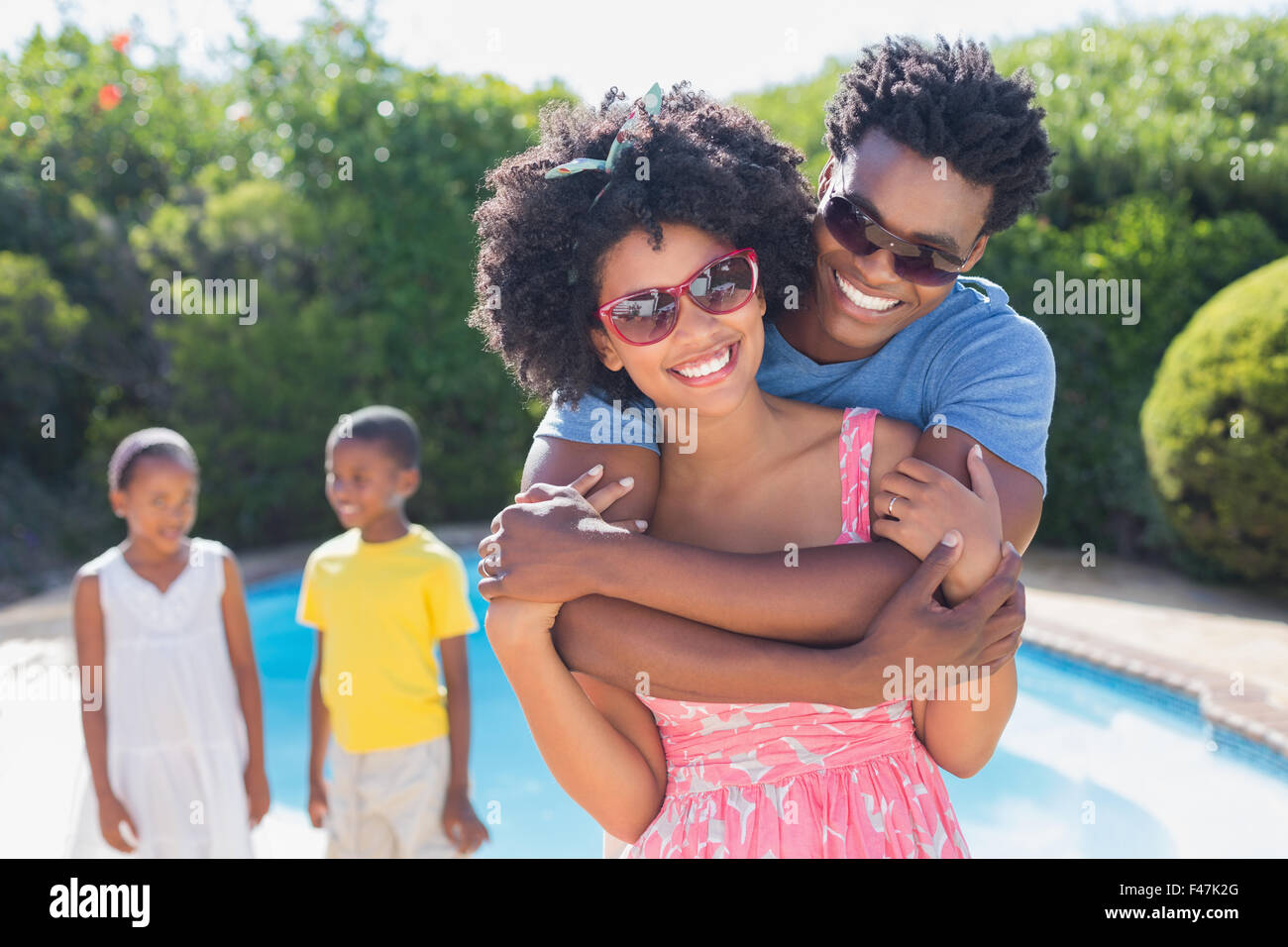 Happy parents smiling at camera Stock Photo - Alamy