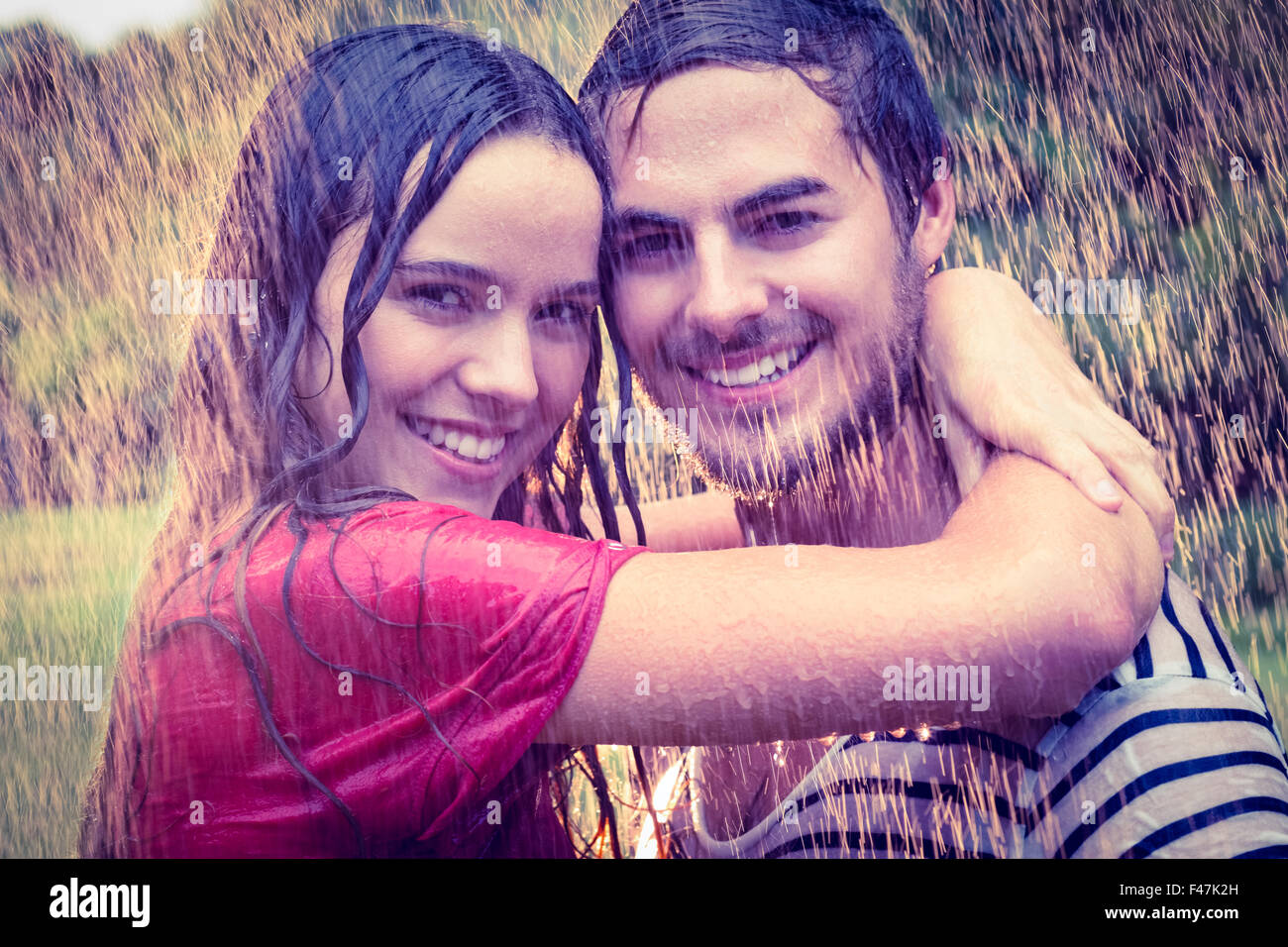 Cute couple hugging under the rain Stock Photo - Alamy