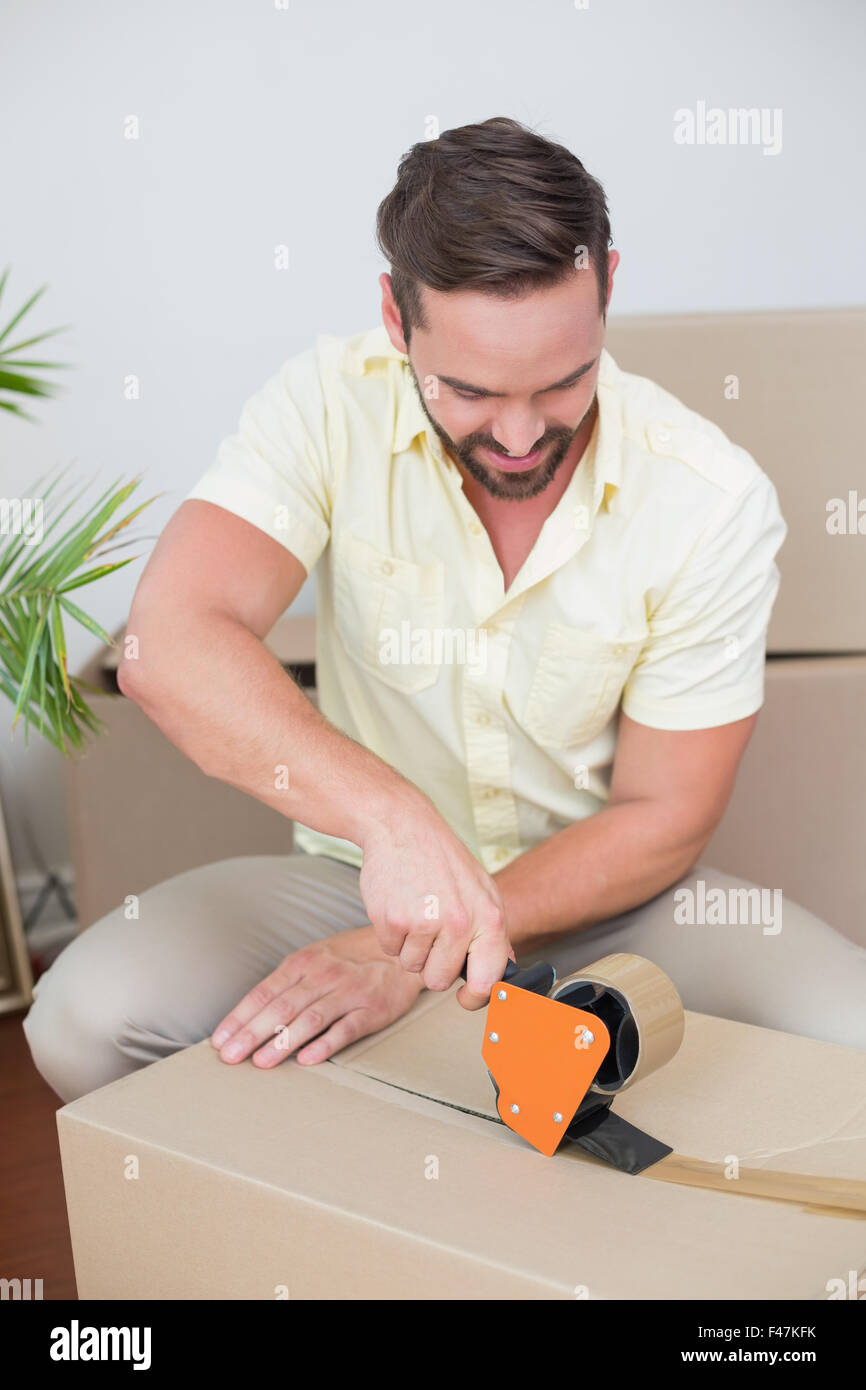 Happy handsome man packing box Stock Photo - Alamy