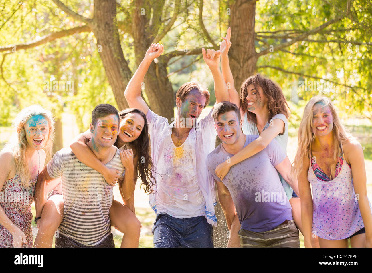 Young friends having fun with powder paint Stock Photo - Alamy