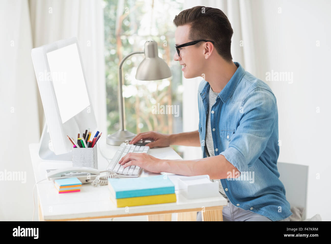 Happy handsome man using computer Stock Photo - Alamy