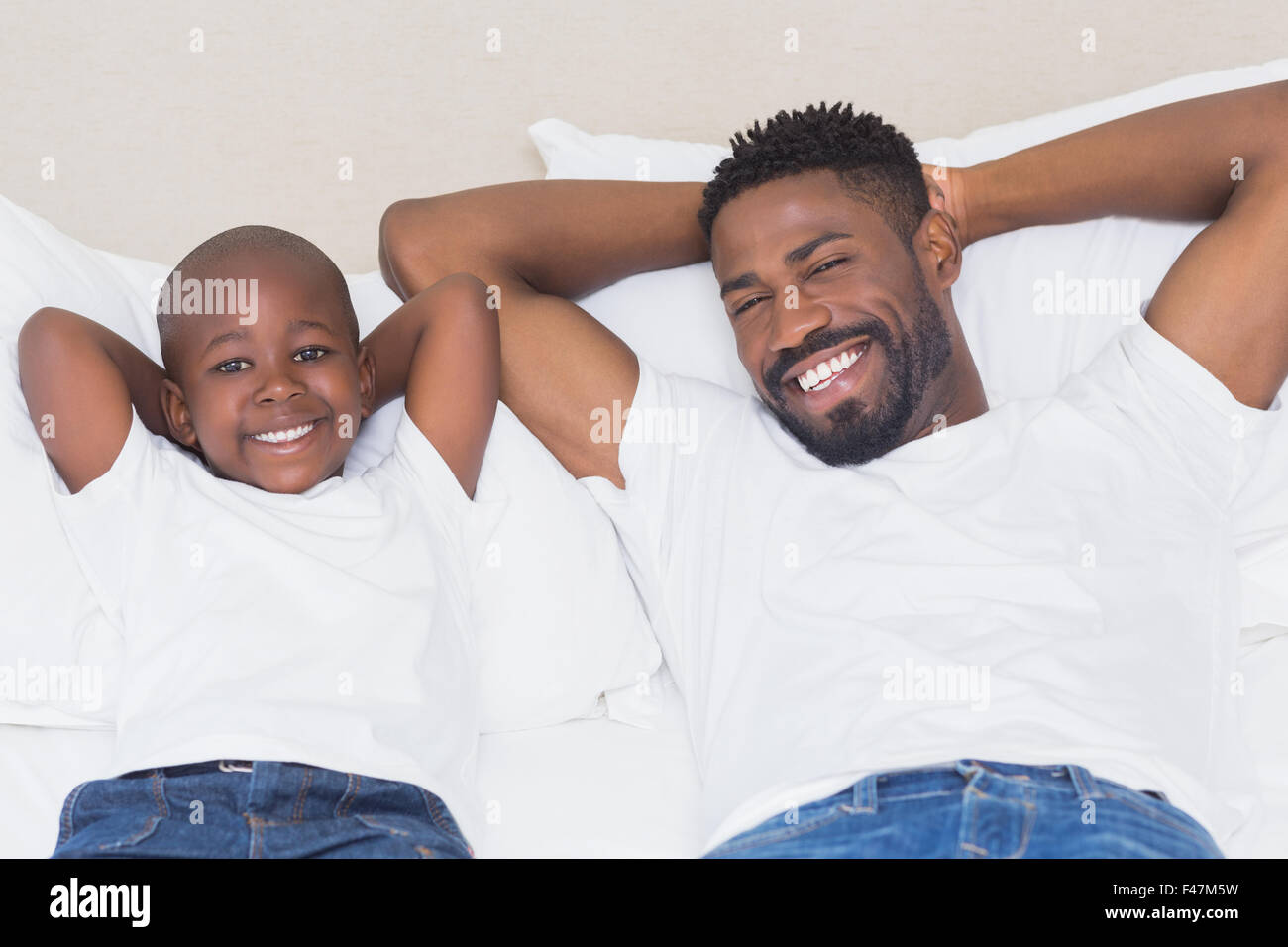 Father and son smiling at camera Stock Photo - Alamy
