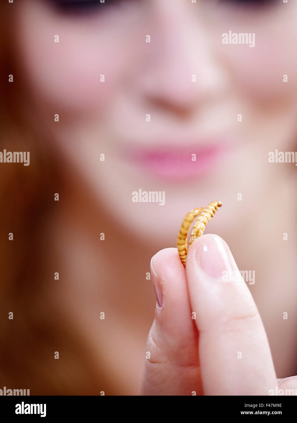 WOMAN EATING INSECT Stock Photo - Alamy