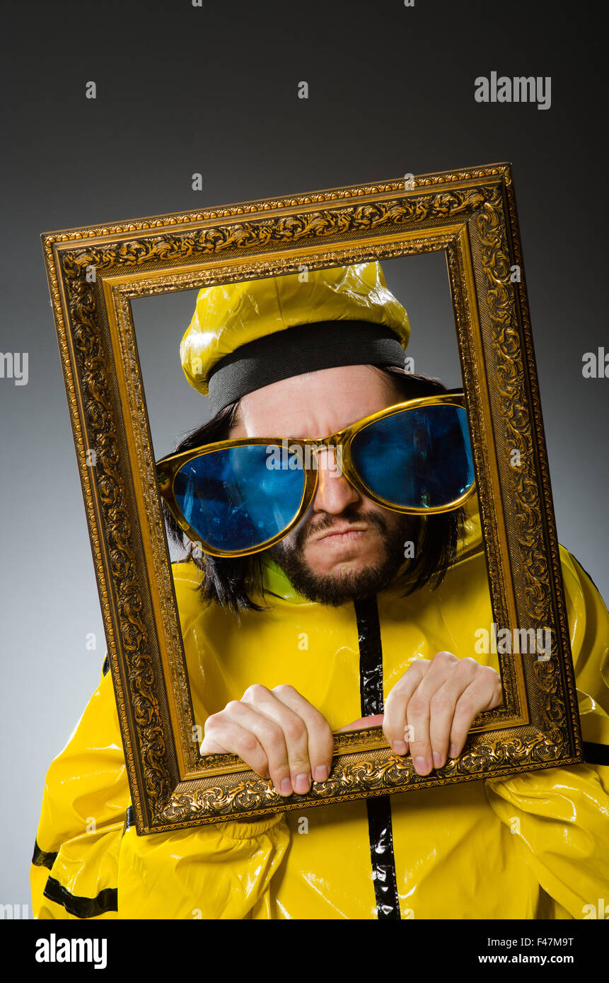 Man wearing yellow suit with picture frame Stock Photo - Alamy