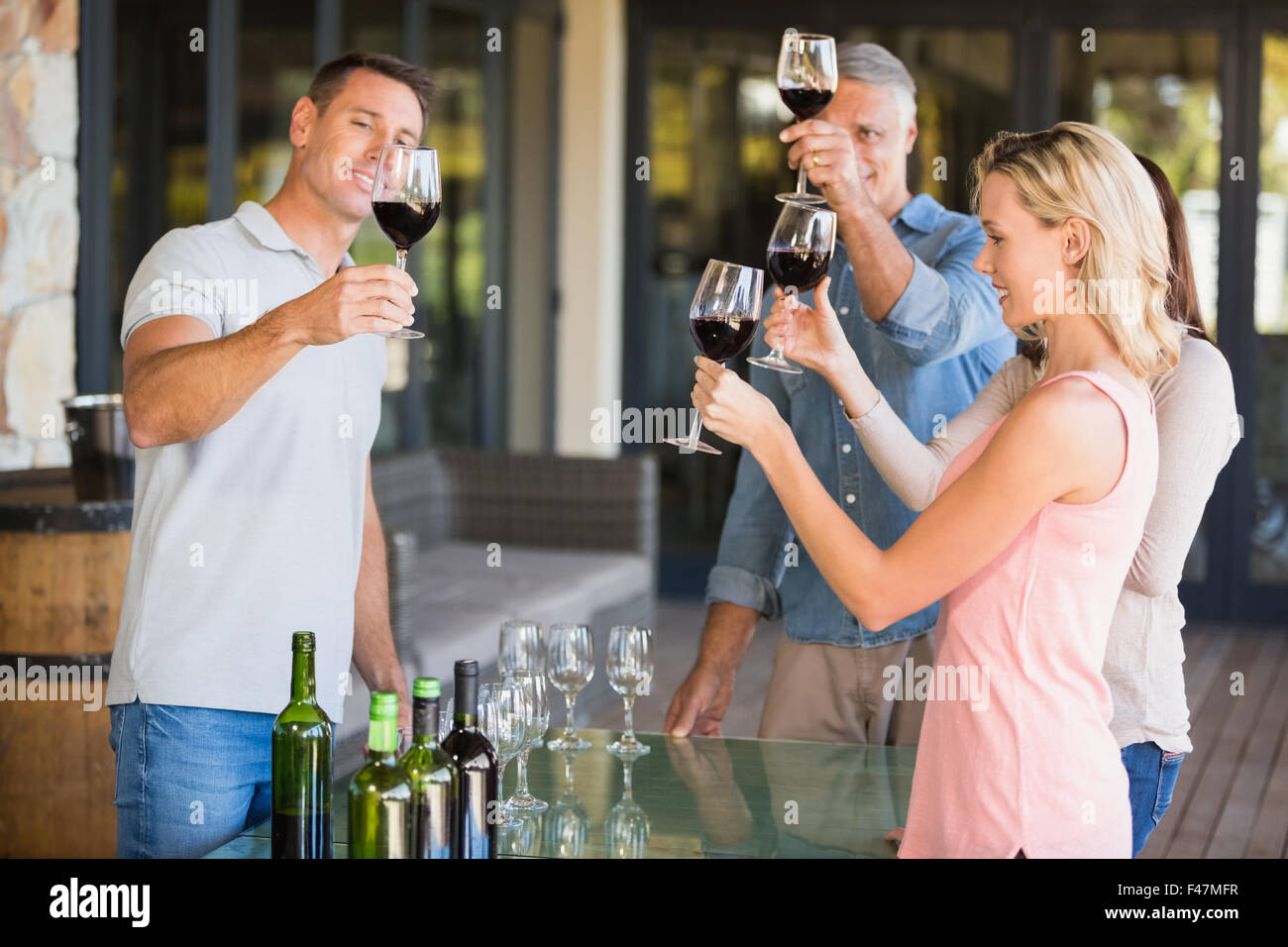 Happy friends in a wine tasting having wine Stock Photo - Alamy