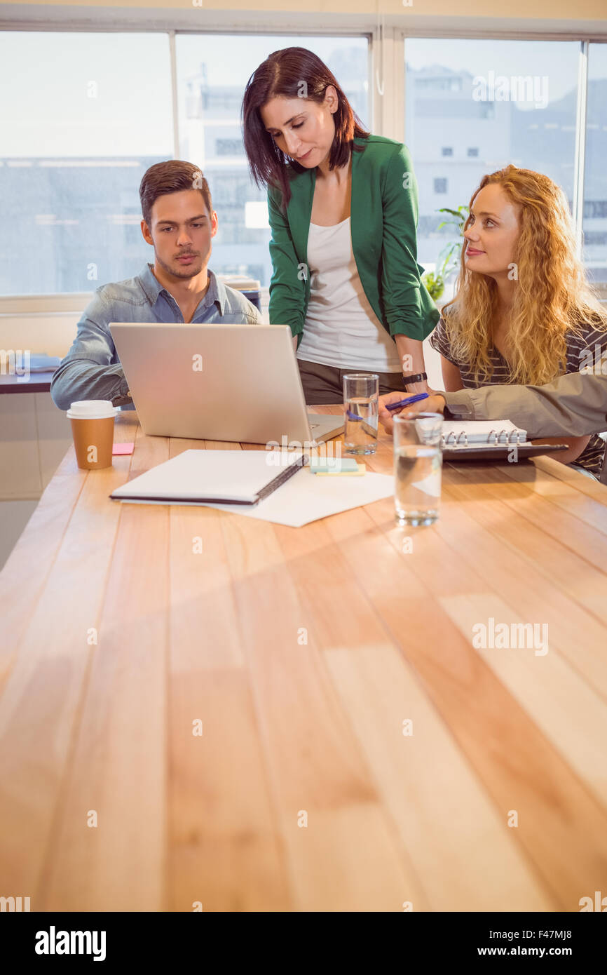 Group of young colleagues using laptop Stock Photo - Alamy