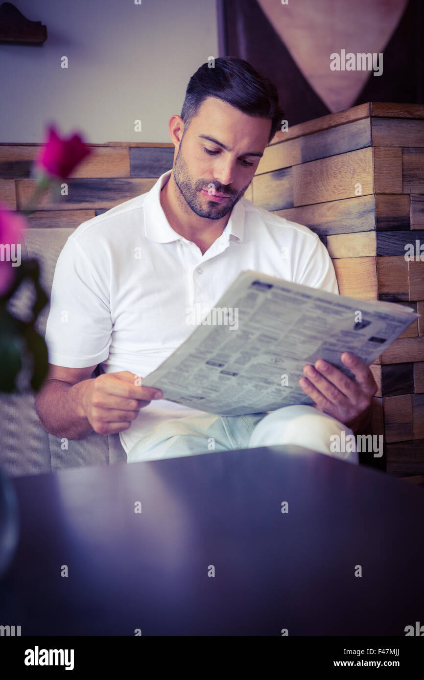 Young man reading newspaper 30s hi-res stock photography and images - Alamy