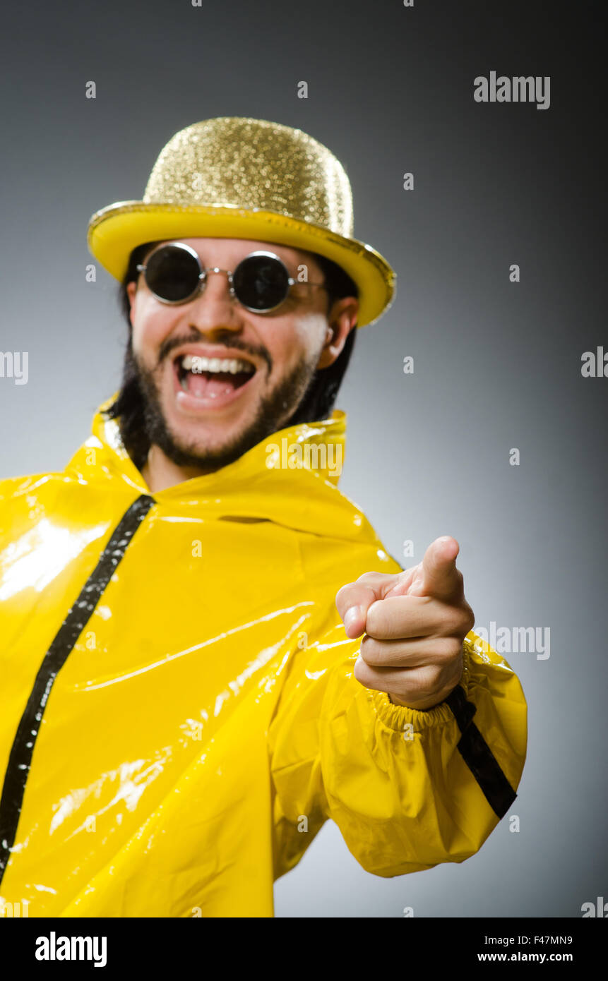 Man wearing yellow suit in funny concept Stock Photo - Alamy