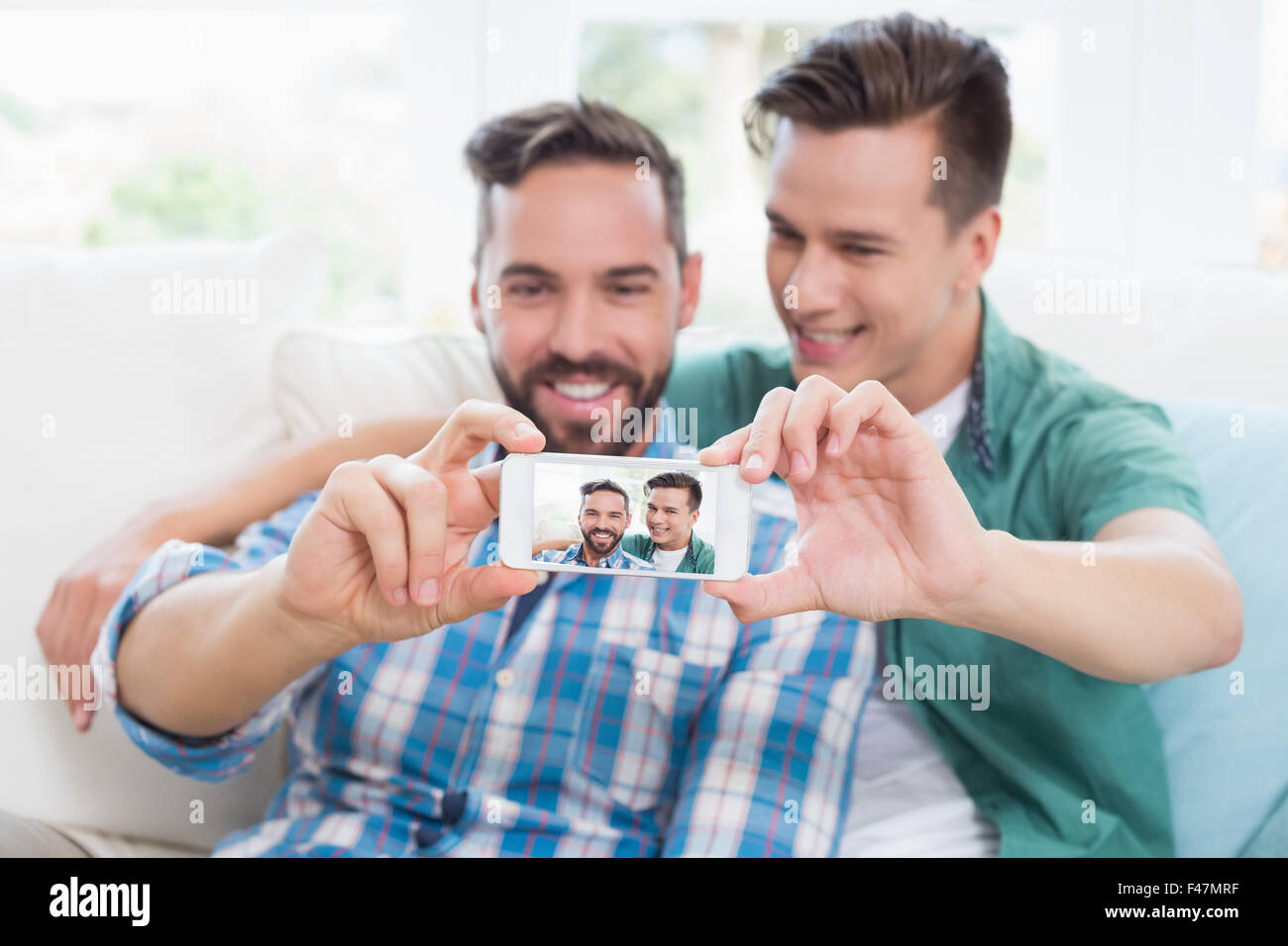 Homosexual couple men taking a selfie Stock Photo - Alamy