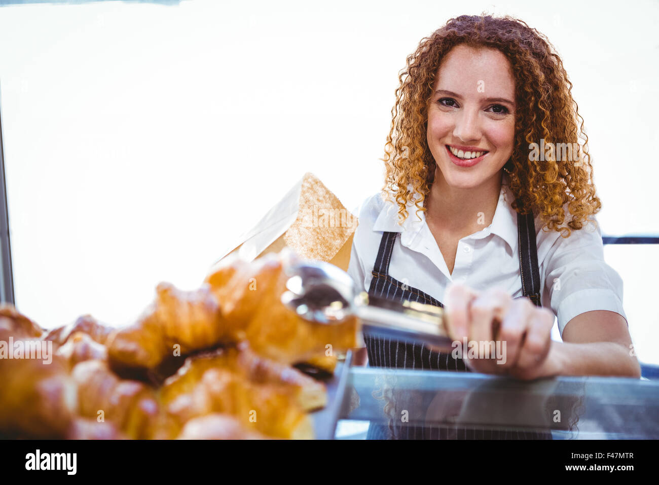Happy pretty barista preparing pastry Stock Photo - Alamy