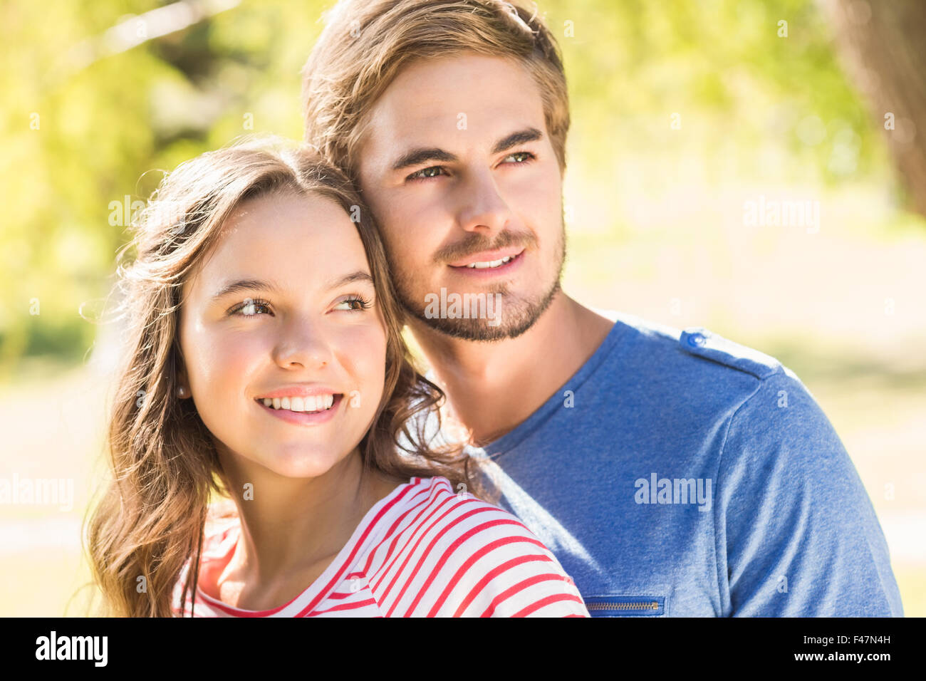 Cute couple hugging in the park Stock Photo - Alamy