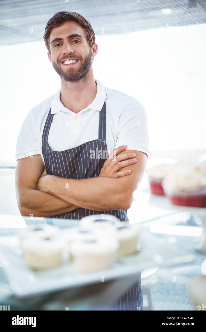Smiling worker posing behind the counter Stock Photo - Alamy