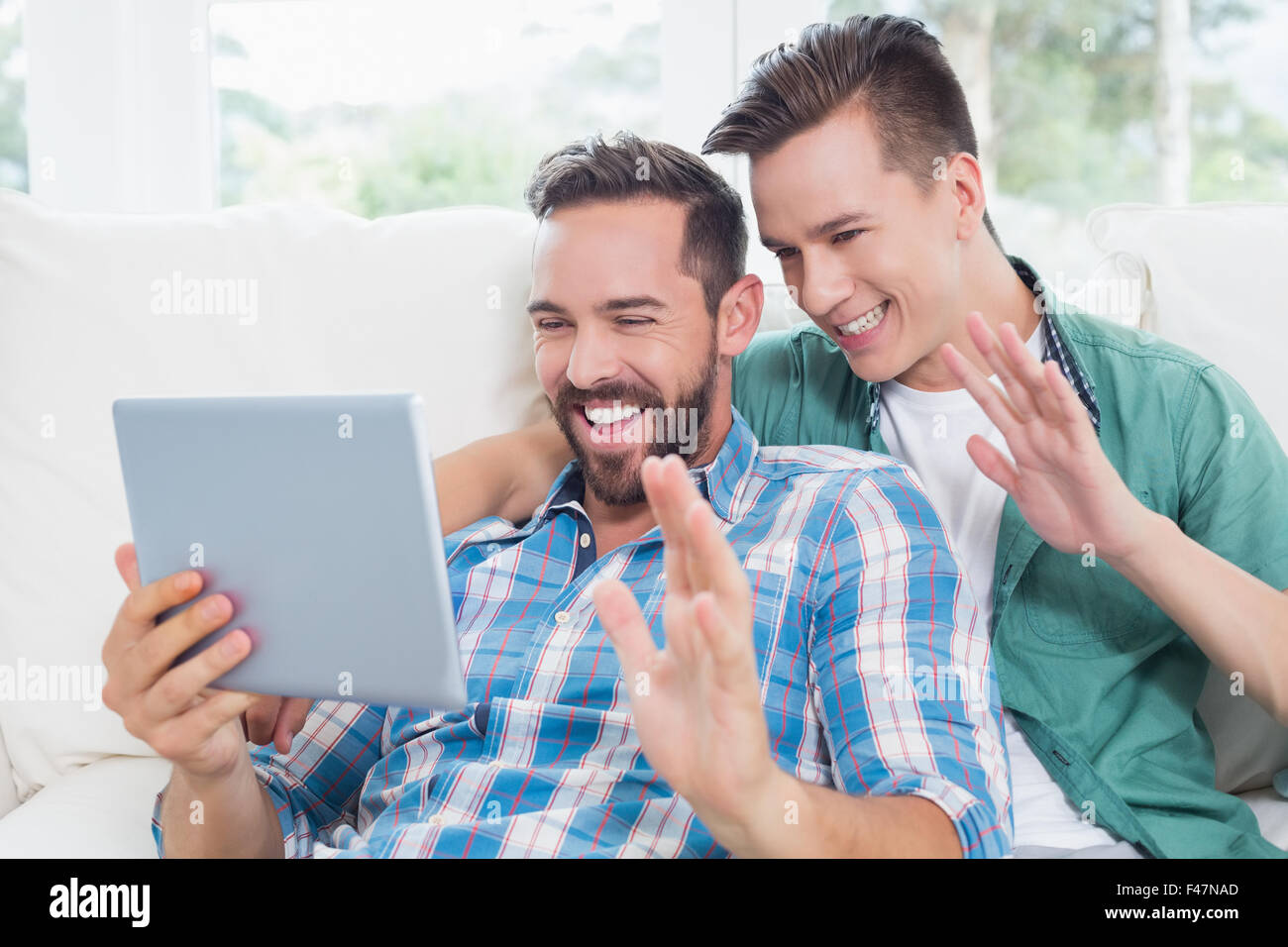 Homosexual couple men gesturing greeting Stock Photo - Alamy