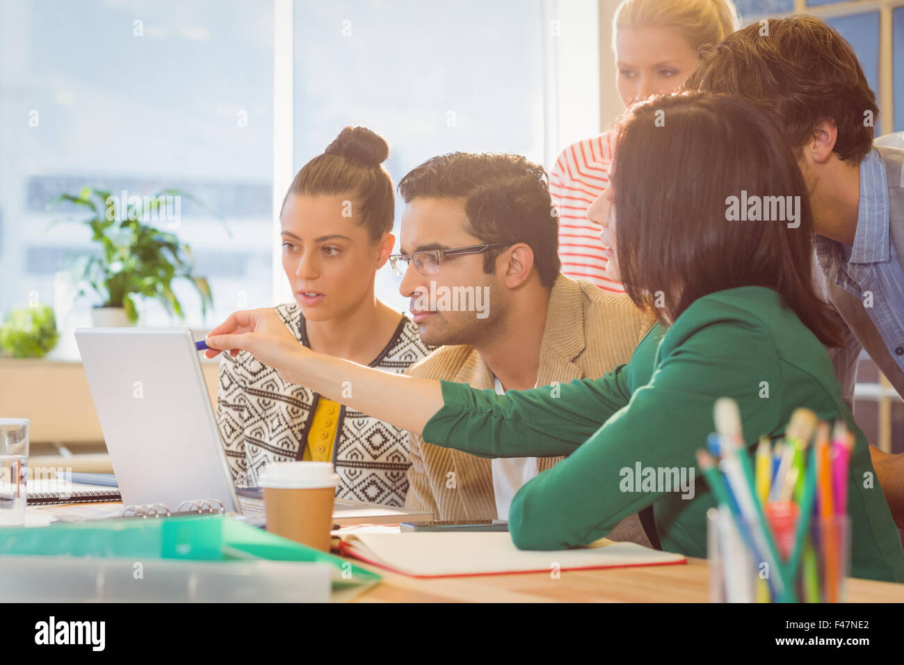 Colleagues using laptop in office Stock Photo - Alamy