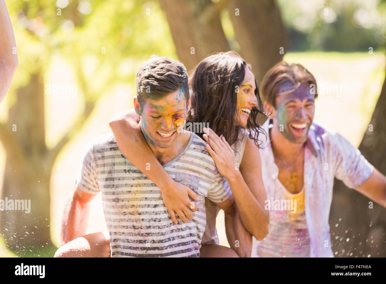 Young friends having fun with powder paint Stock Photo - Alamy