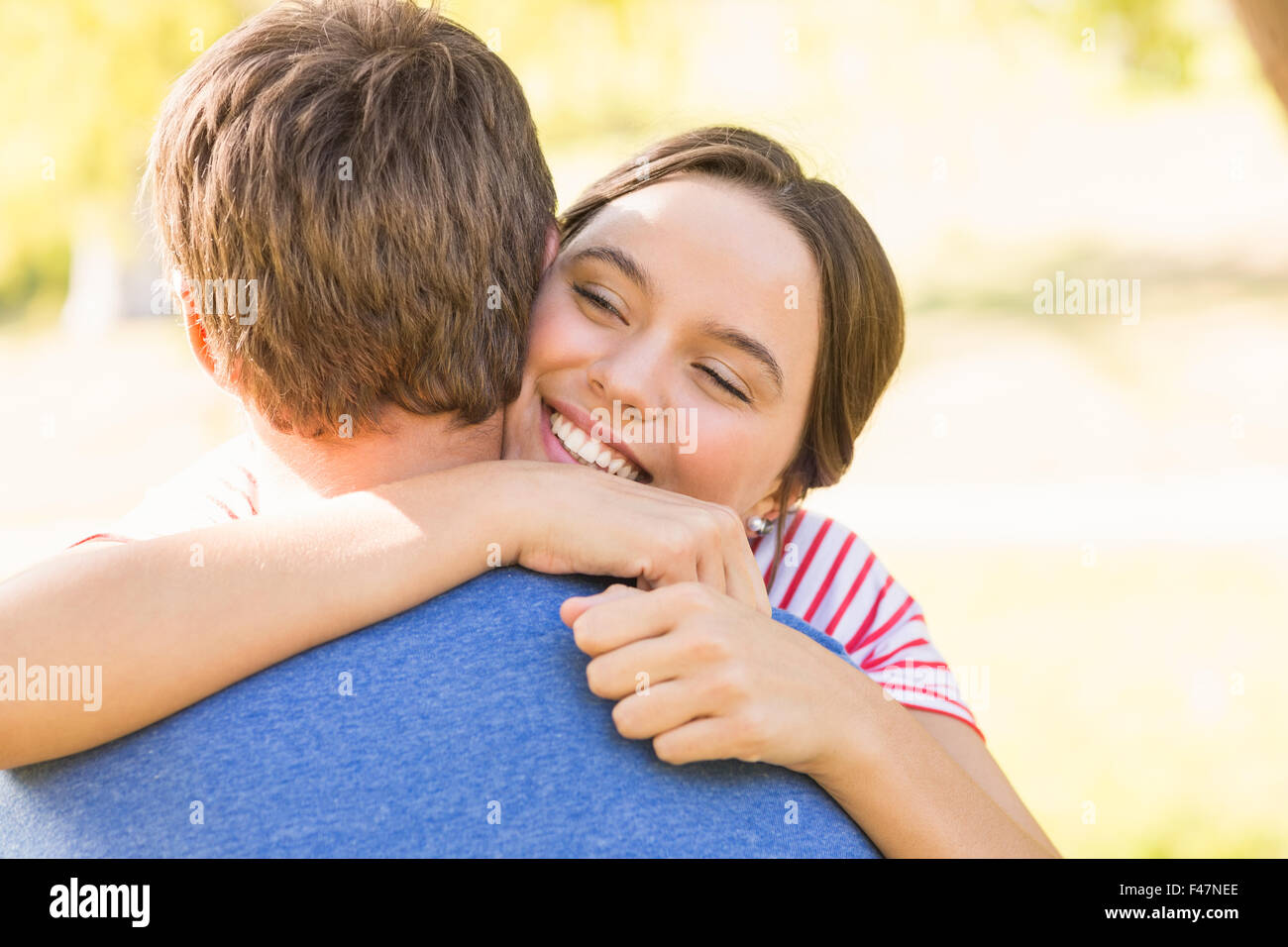 Cute couple hugging in the park Stock Photo - Alamy