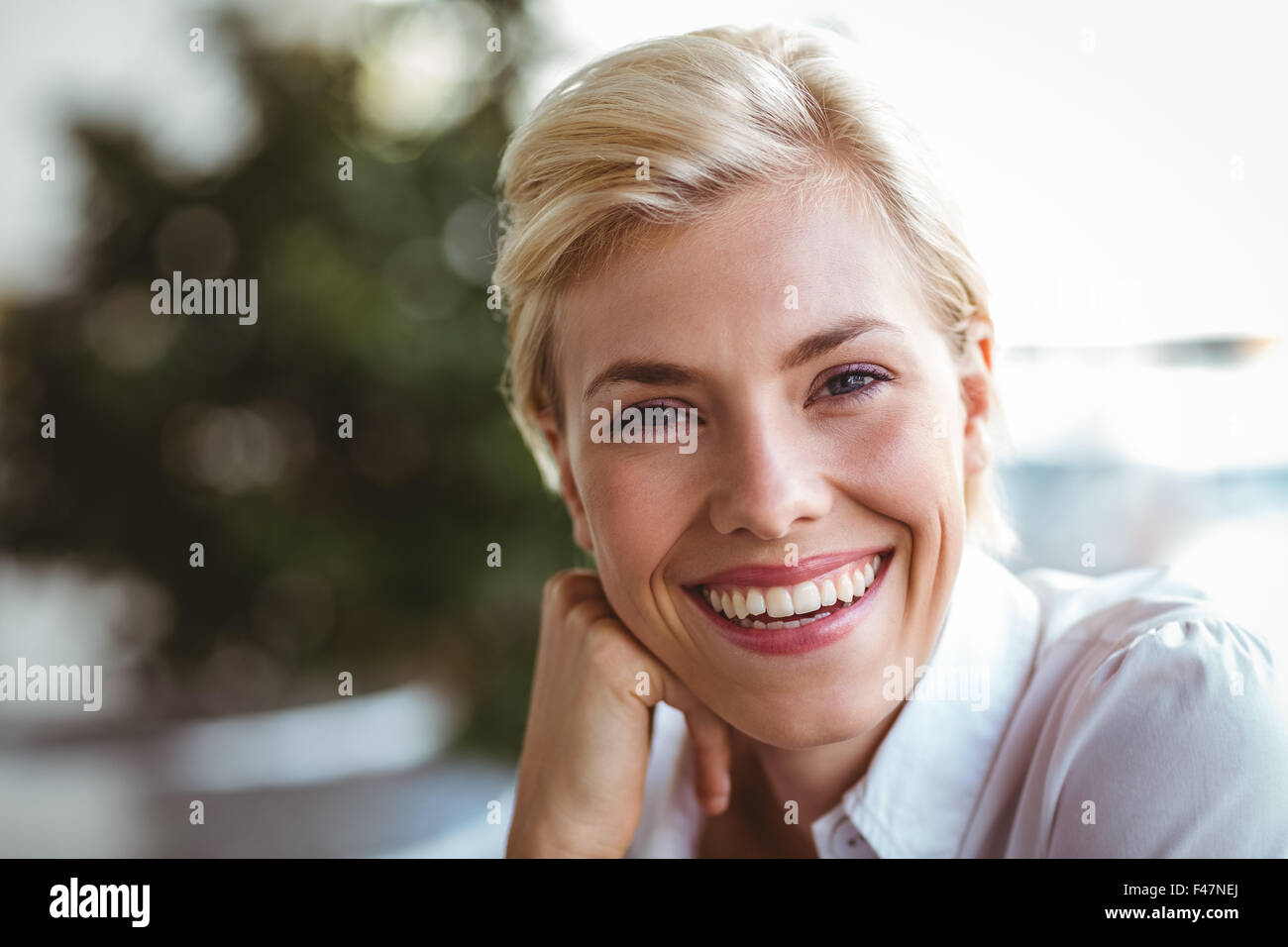 Cafe owner smiling at the camera Stock Photo - Alamy