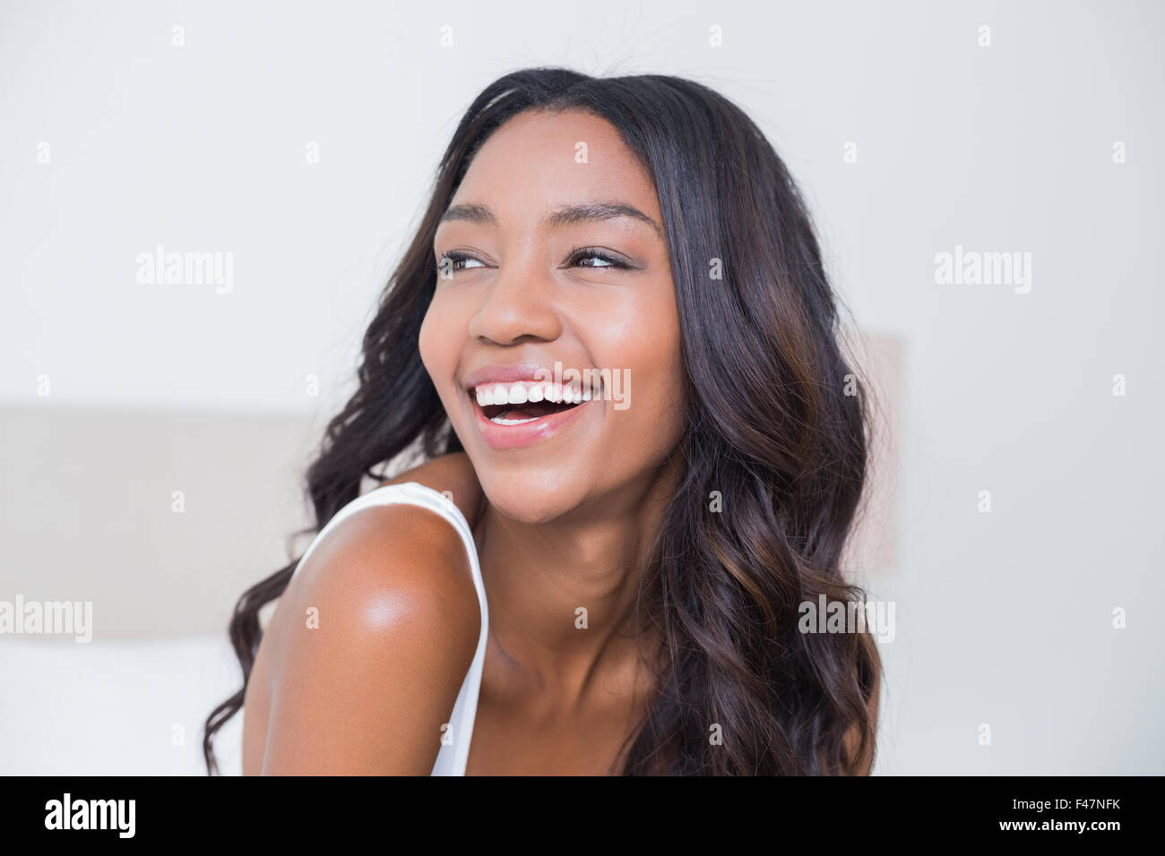 Beautiful woman laughing on bed hi-res stock photography and images - Alamy