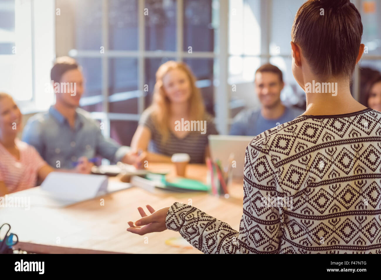Group of young colleagues using laptop Stock Photo - Alamy