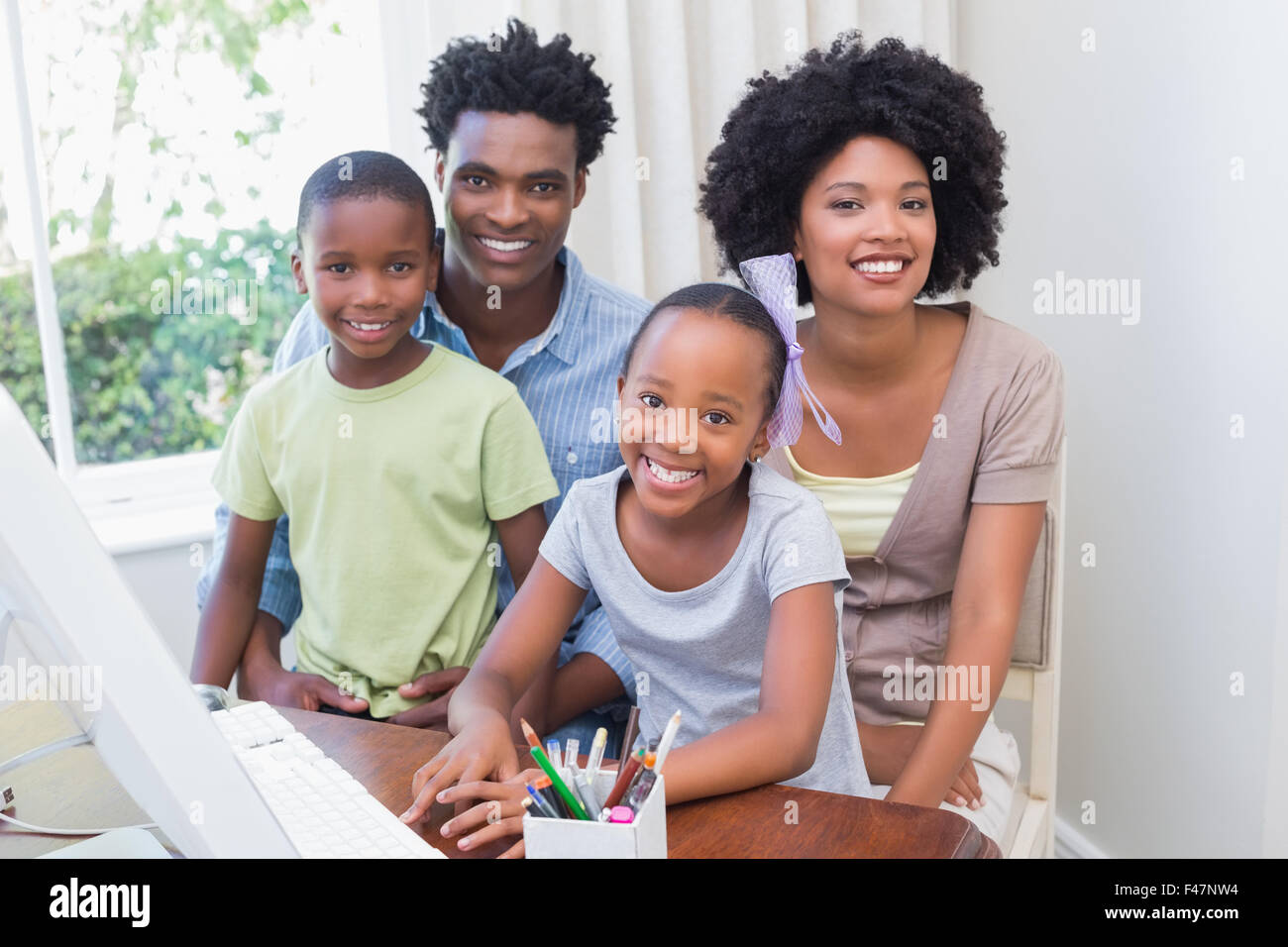 Happy family using the computer Stock Photo - Alamy