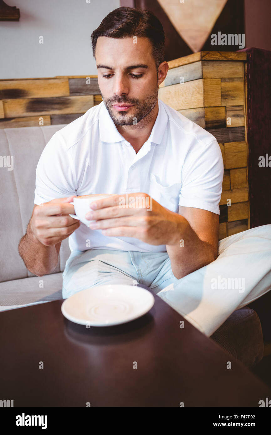 Young man drinking cup of coffee Stock Photo - Alamy