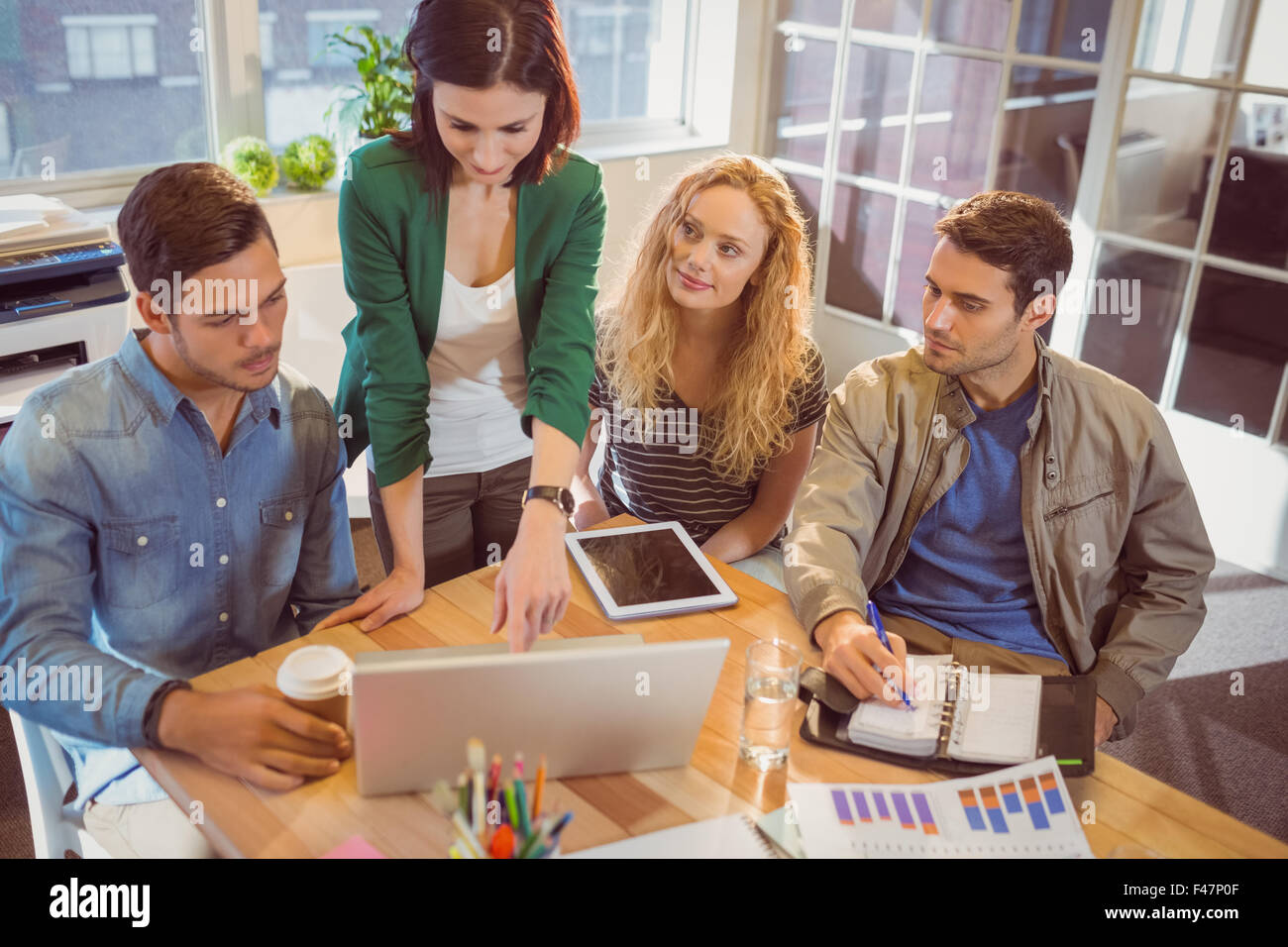 Group of young colleagues using laptop Stock Photo - Alamy