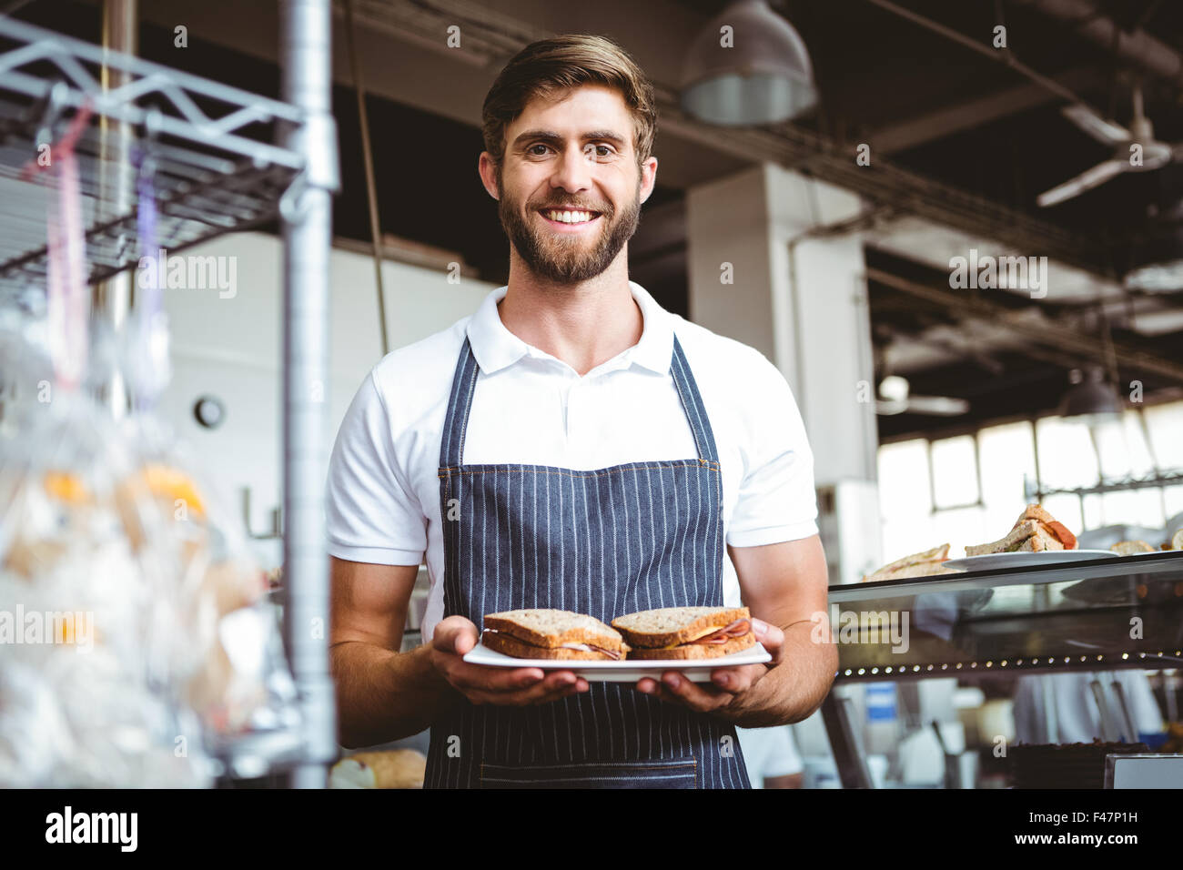 happy worker holding sandwiches Stock Photo - Alamy