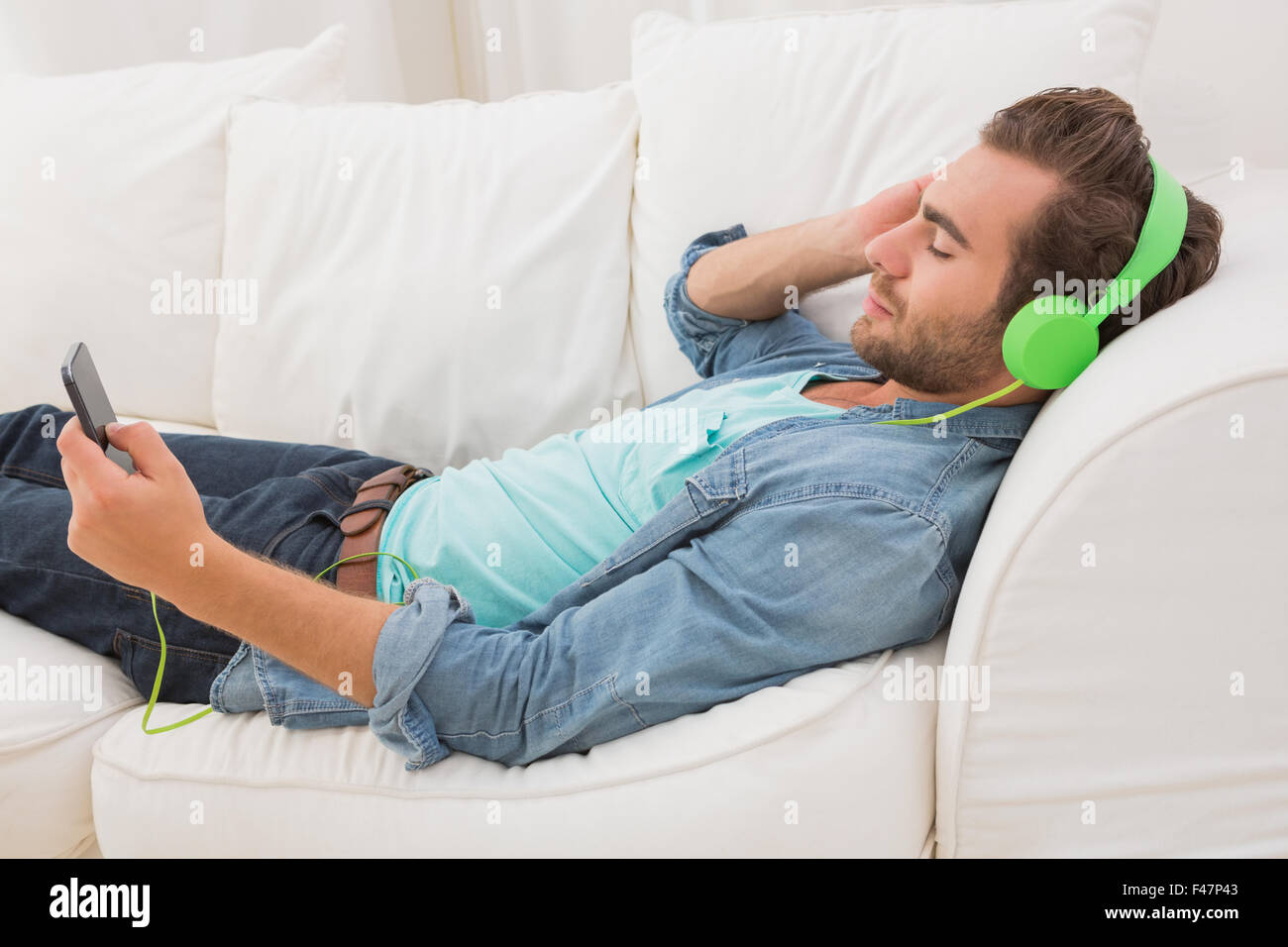 Handsome man listening music with his smartphone Stock Photo - Alamy