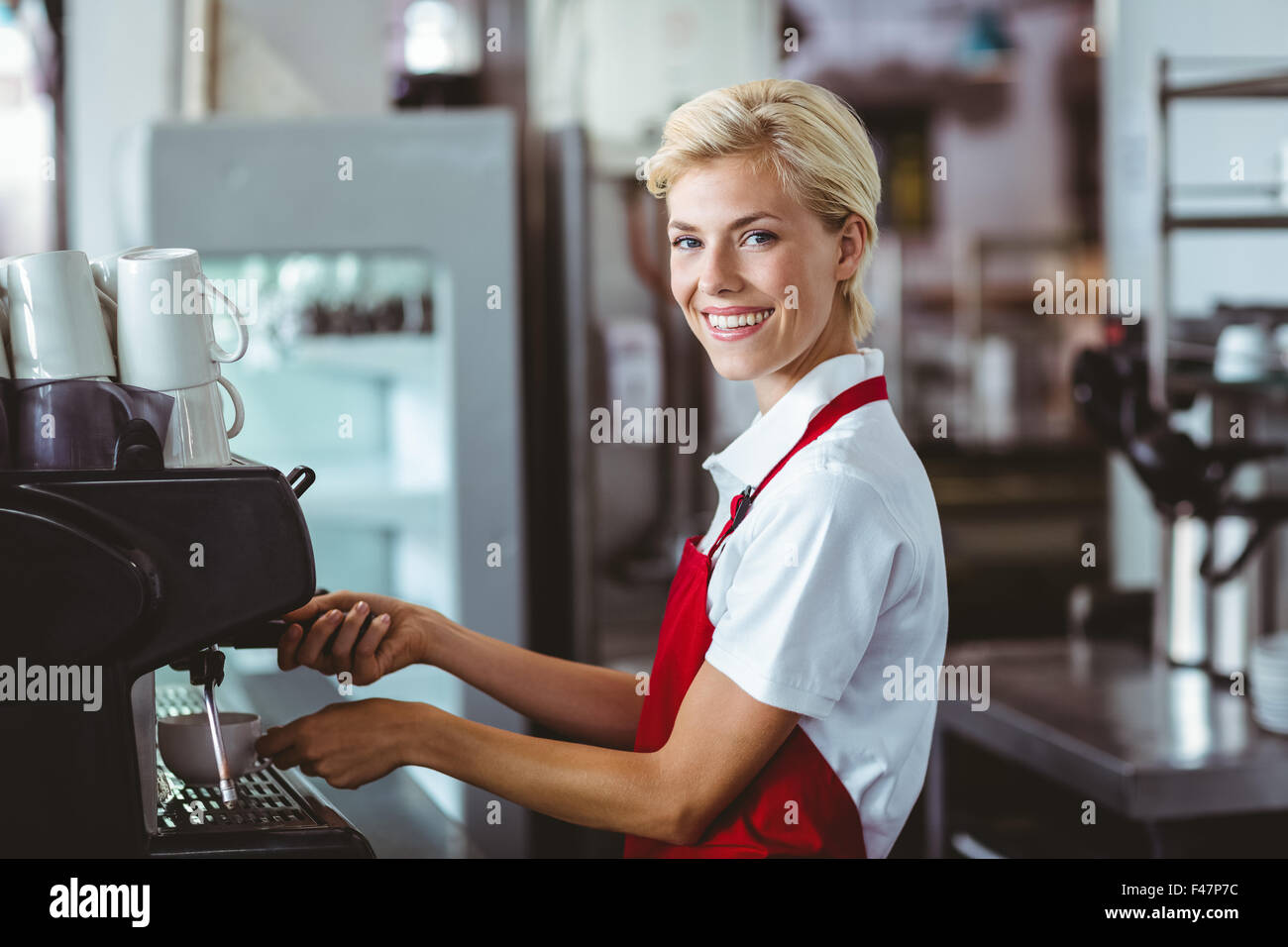 Pretty barista using the coffee machine Stock Photo - Alamy