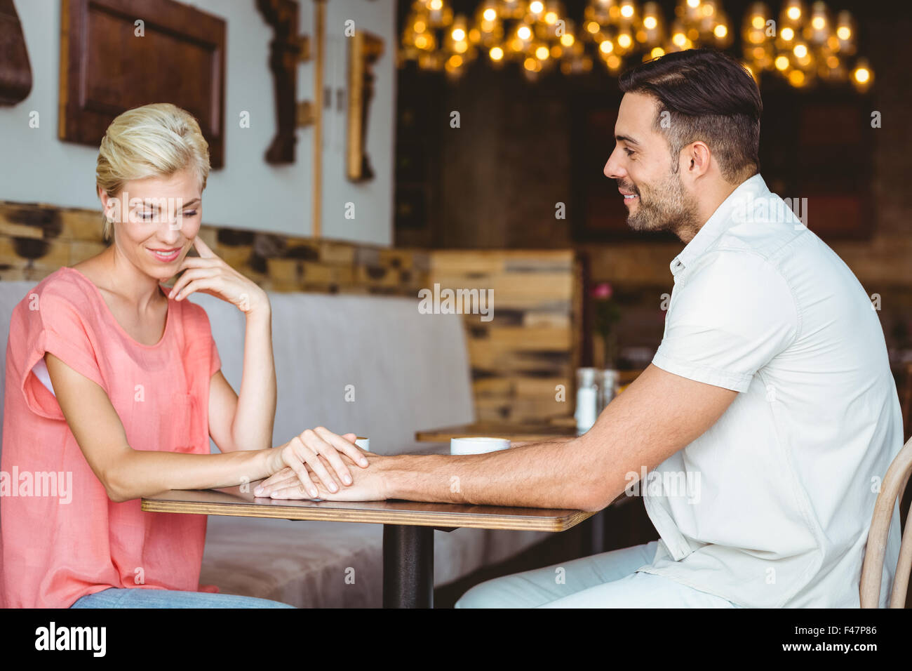 Cute couple on a date holding hands Stock Photo - Alamy