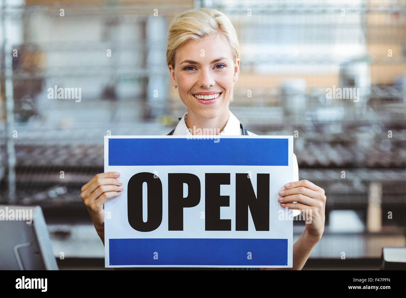 Cafe owner smiling at the camera Stock Photo - Alamy