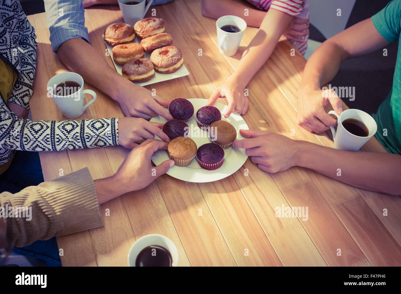 Business people taking cakes on table Stock Photo - Alamy