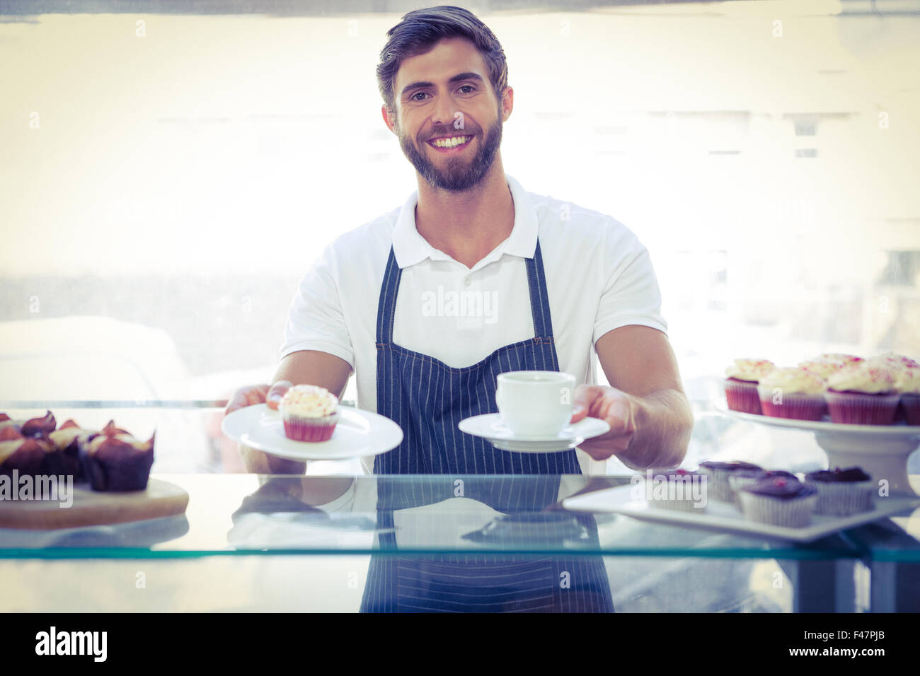 Smiling worker prepares breakfast Stock Photo - Alamy