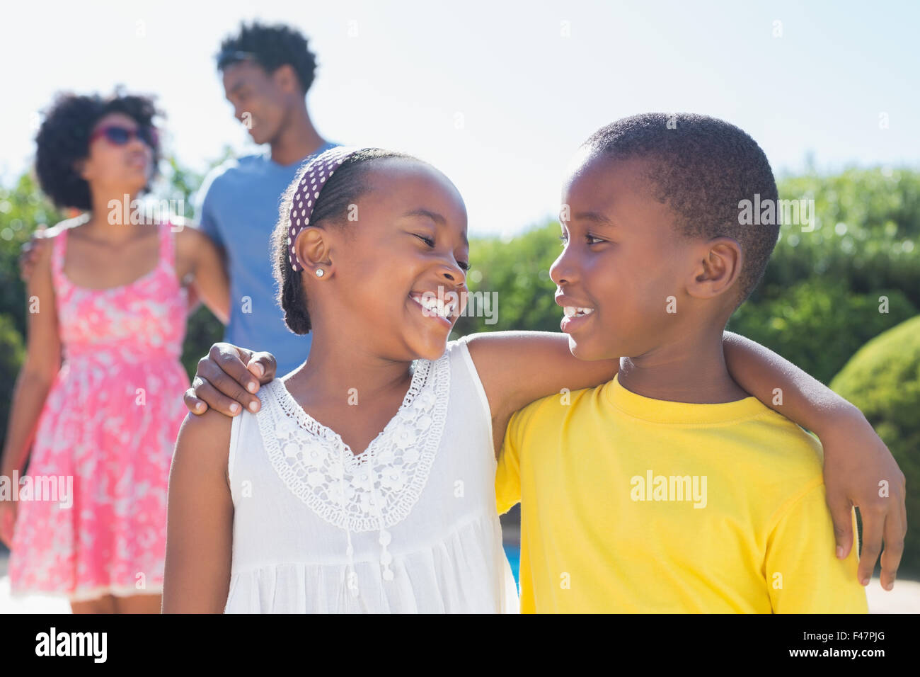 Happy siblings smiling at each other Stock Photo - Alamy