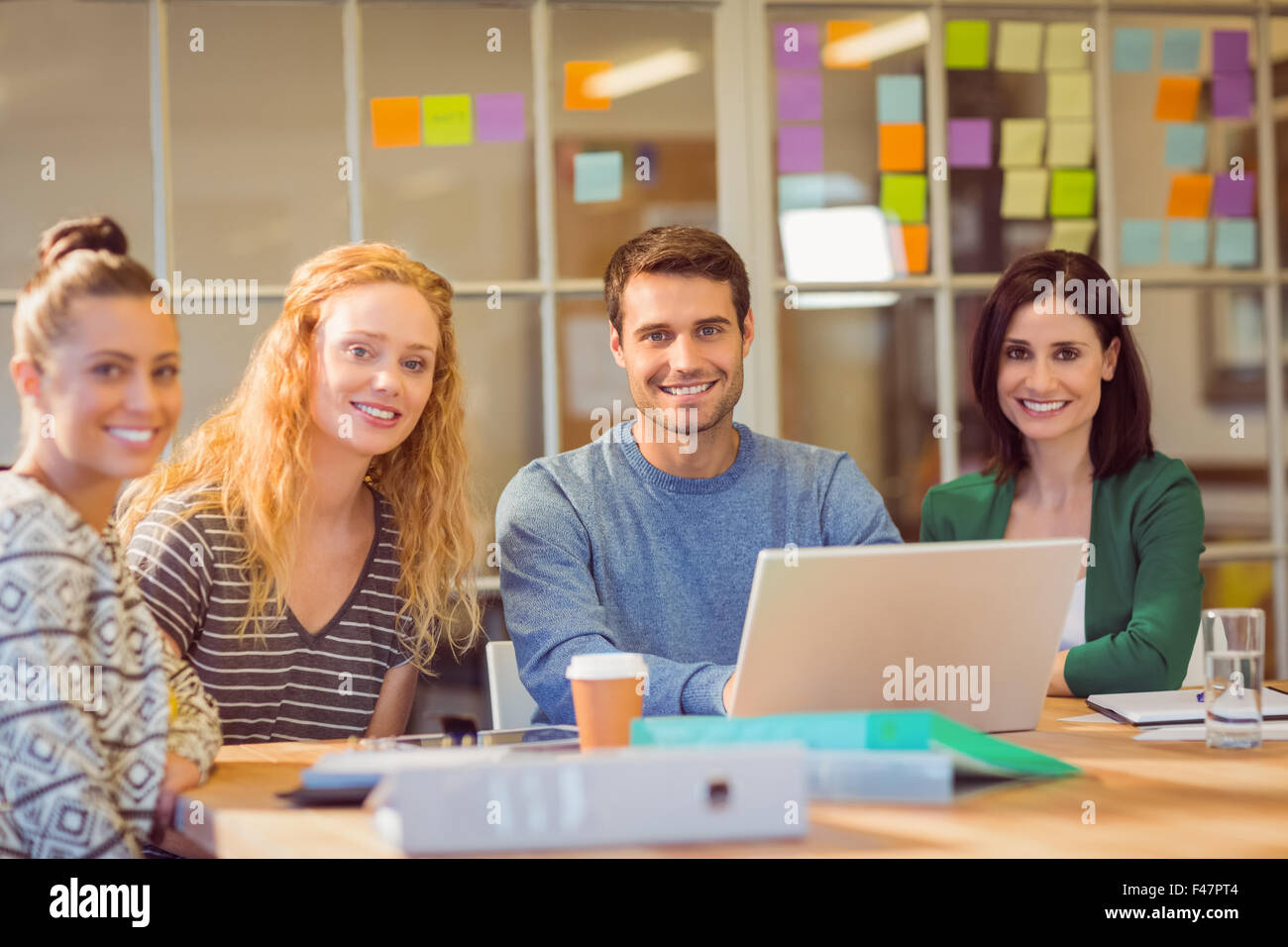 Group of young colleagues using laptop Stock Photo - Alamy