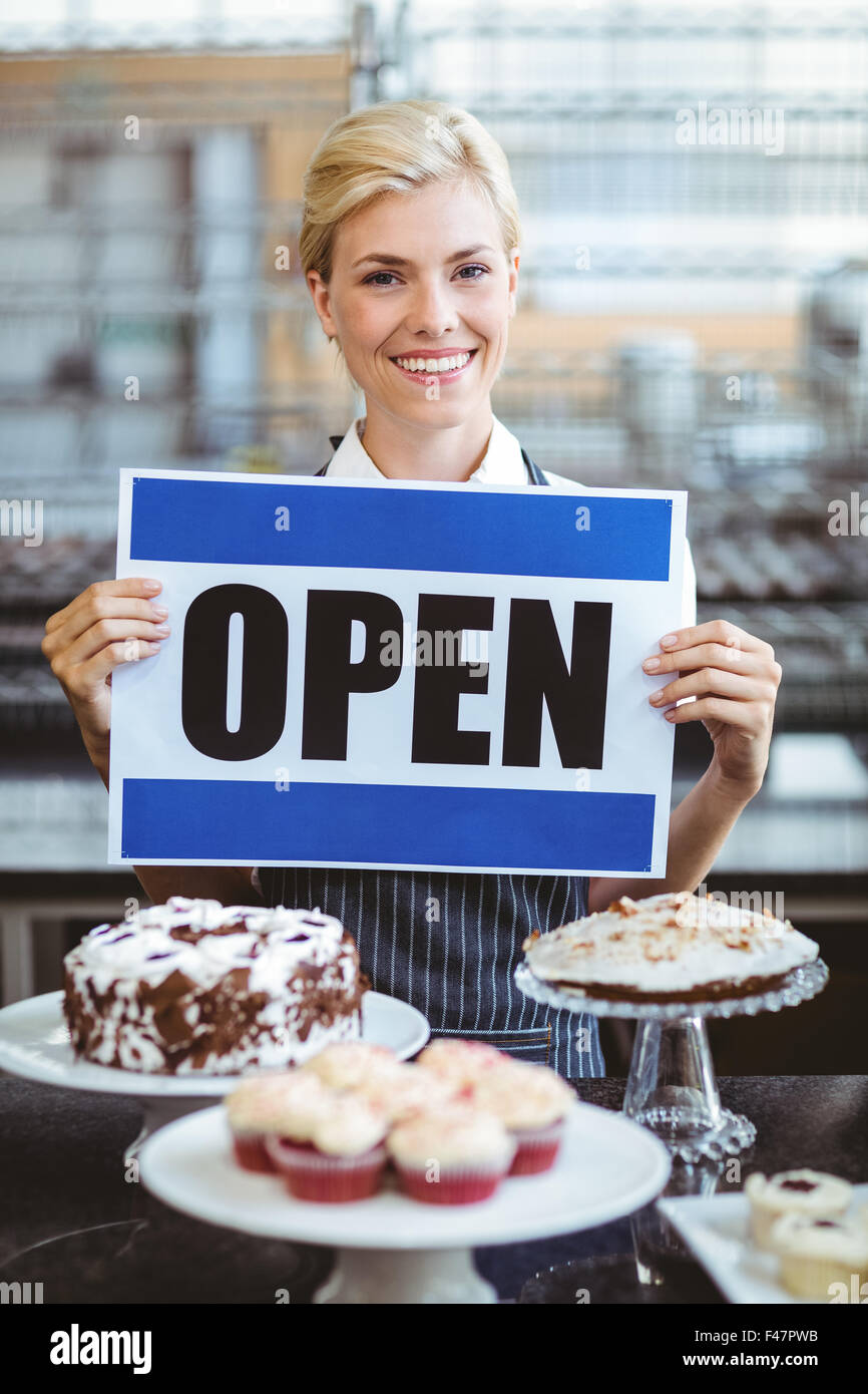 Cafe owner smiling at the camera Stock Photo - Alamy