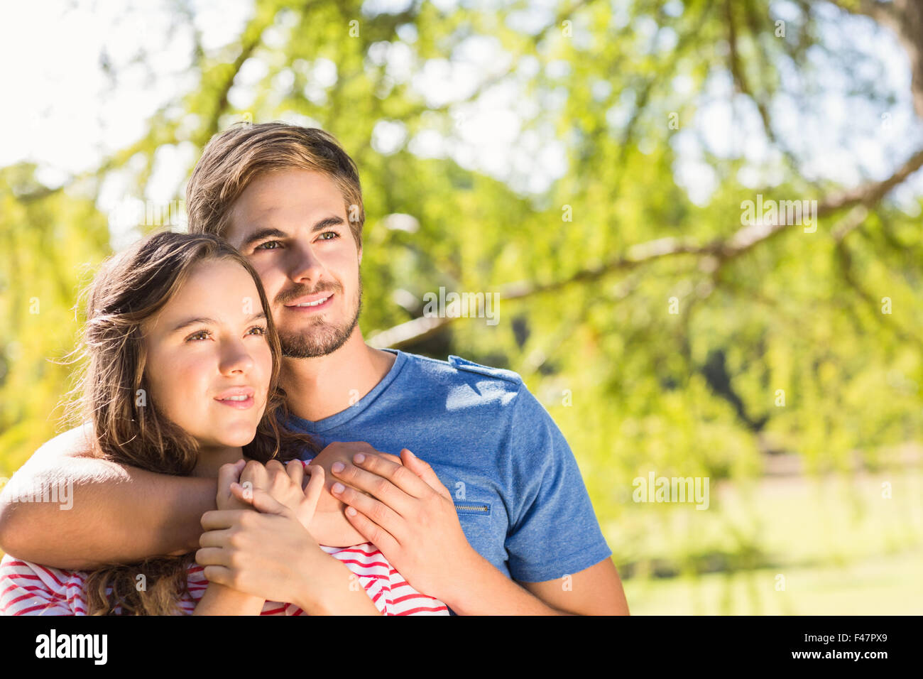 Cute couple hugging in the park Stock Photo - Alamy