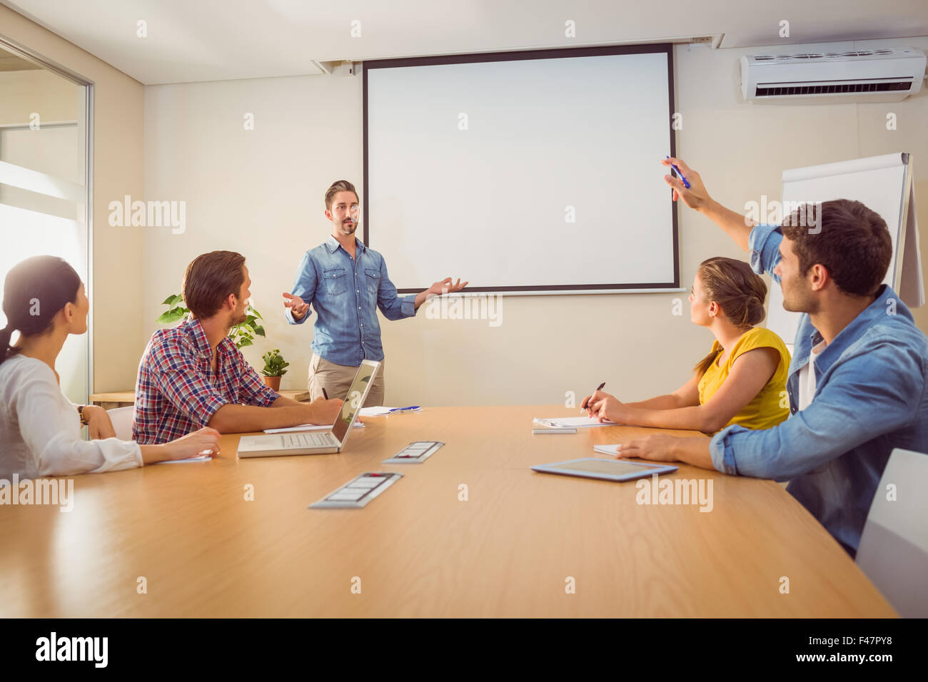 Attentive businessman asking a question Stock Photo - Alamy