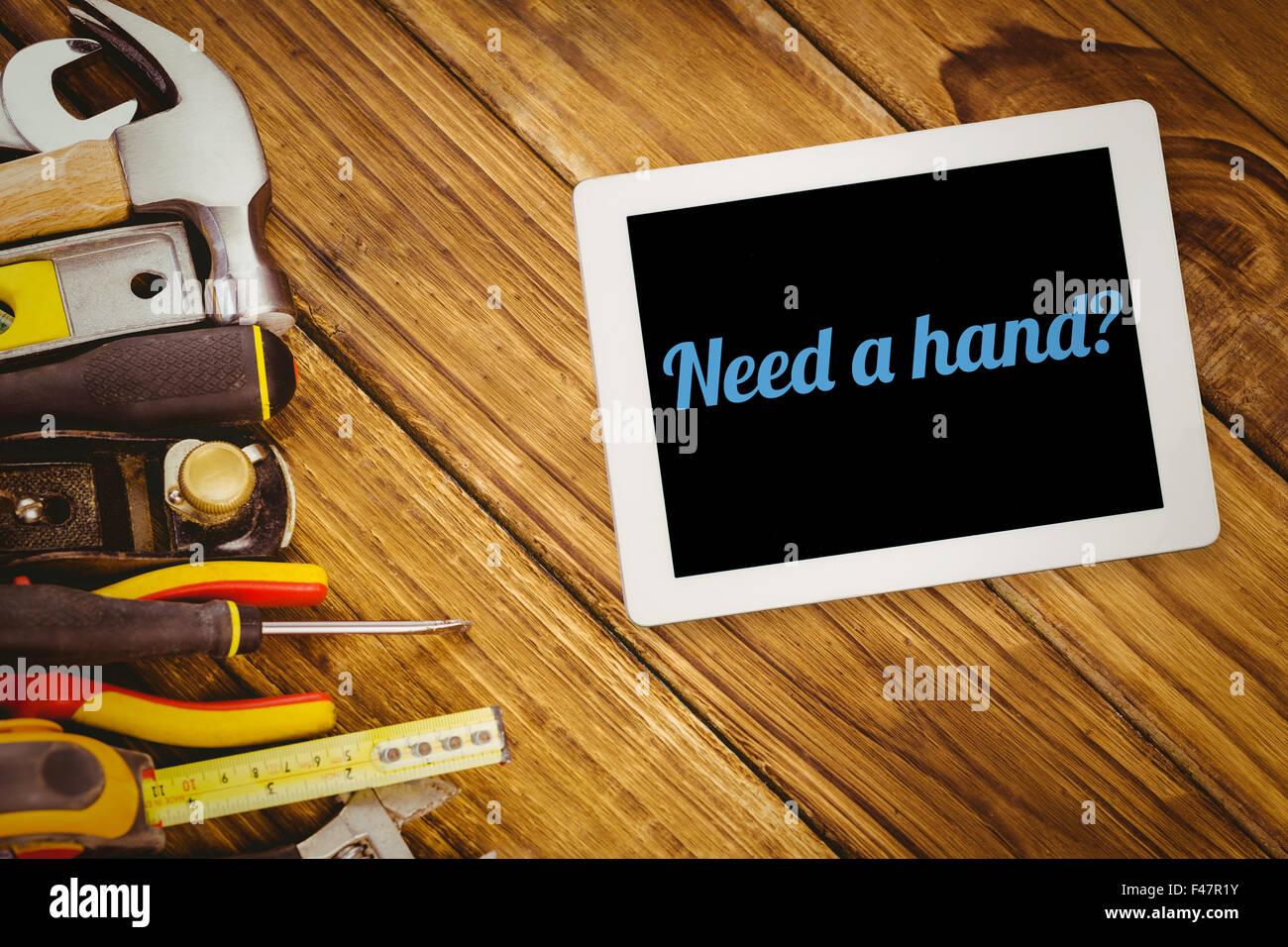 Need a hand? against desk with tools Stock Photo - Alamy