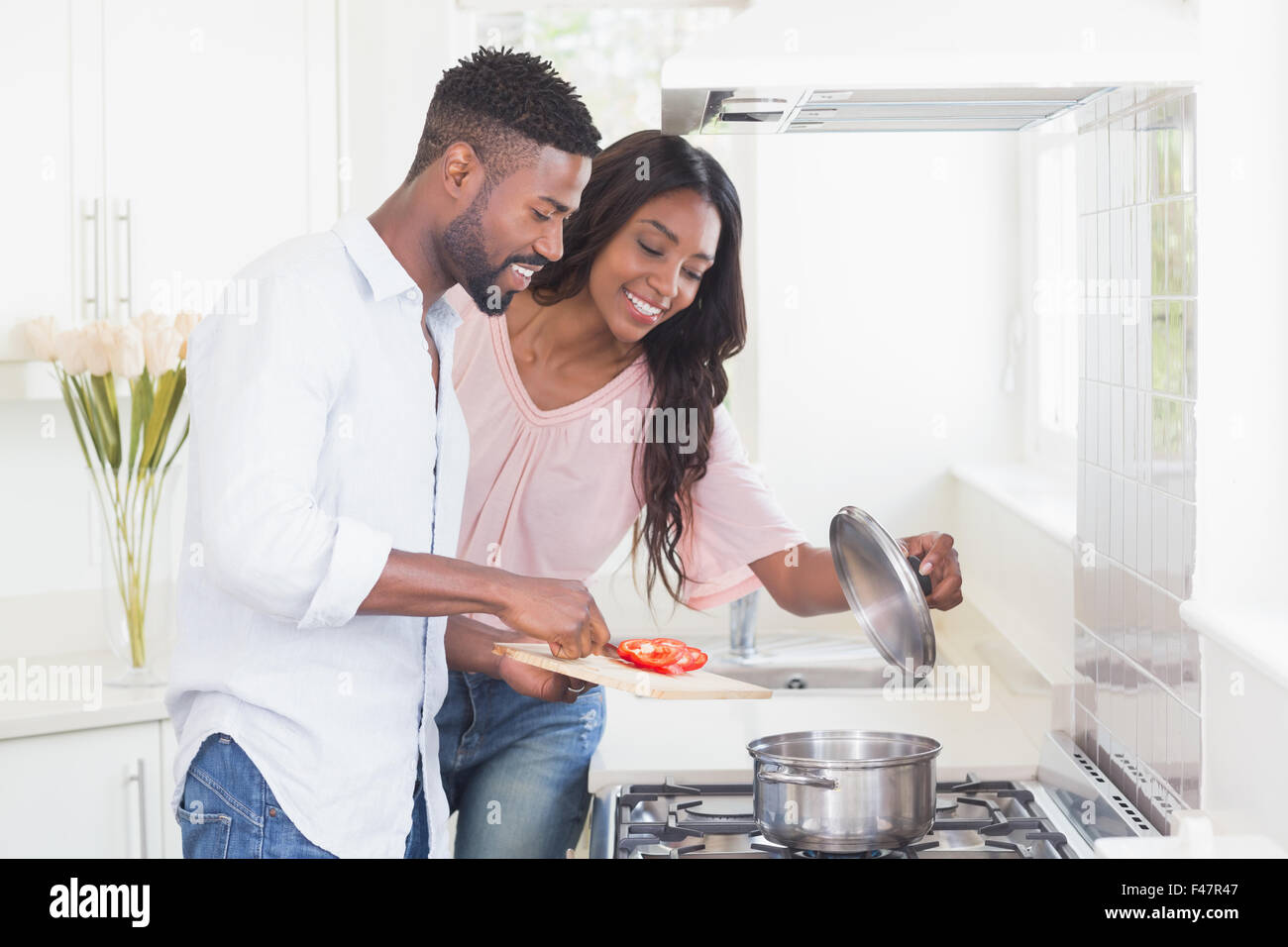 Happy couple cooking food together Stock Photo - Alamy