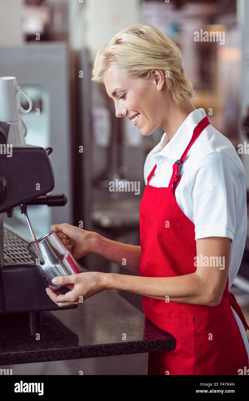 Pretty barista using the coffee machine Stock Photo - Alamy