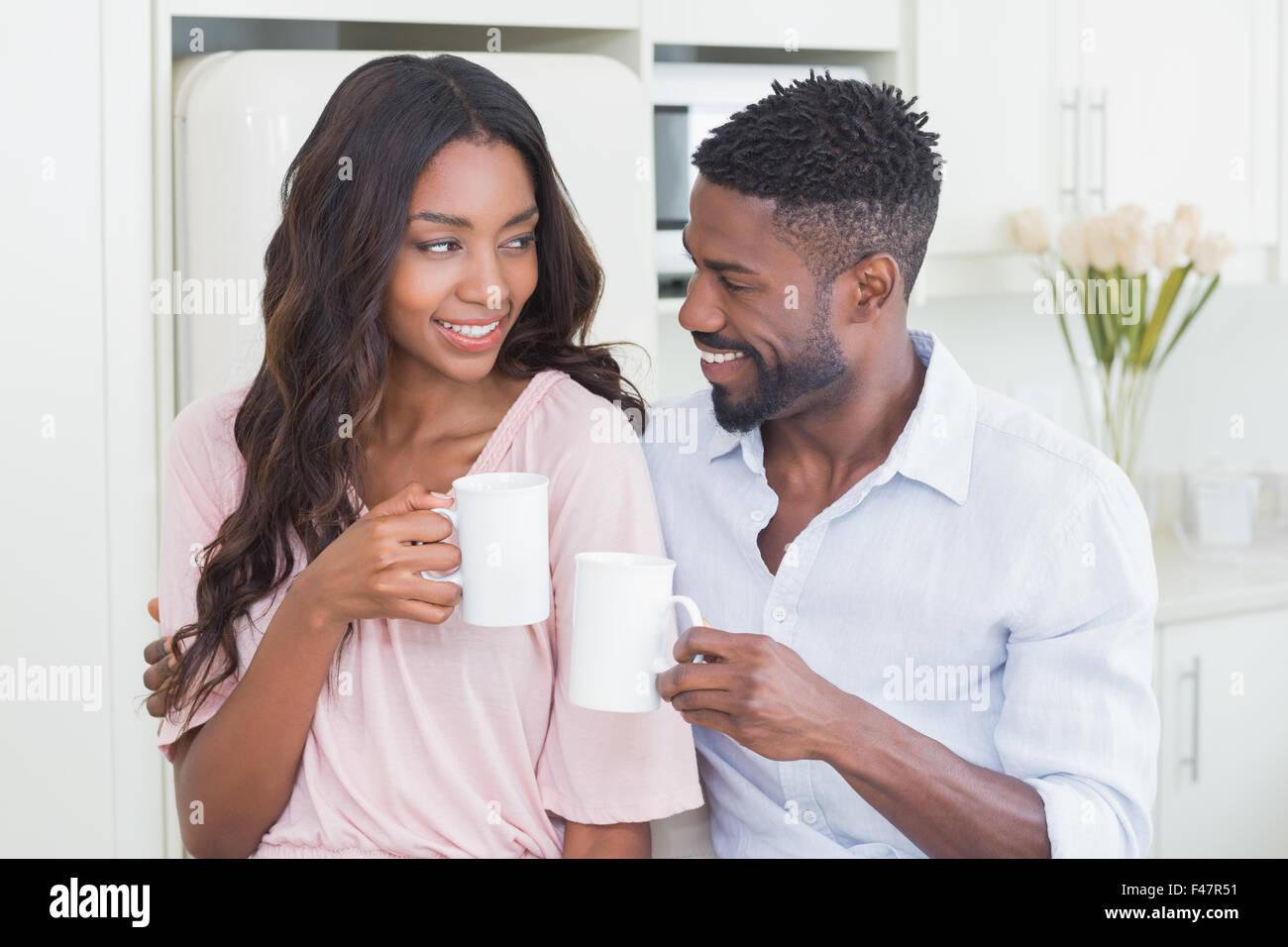 Happy couple having coffee together Stock Photo - Alamy