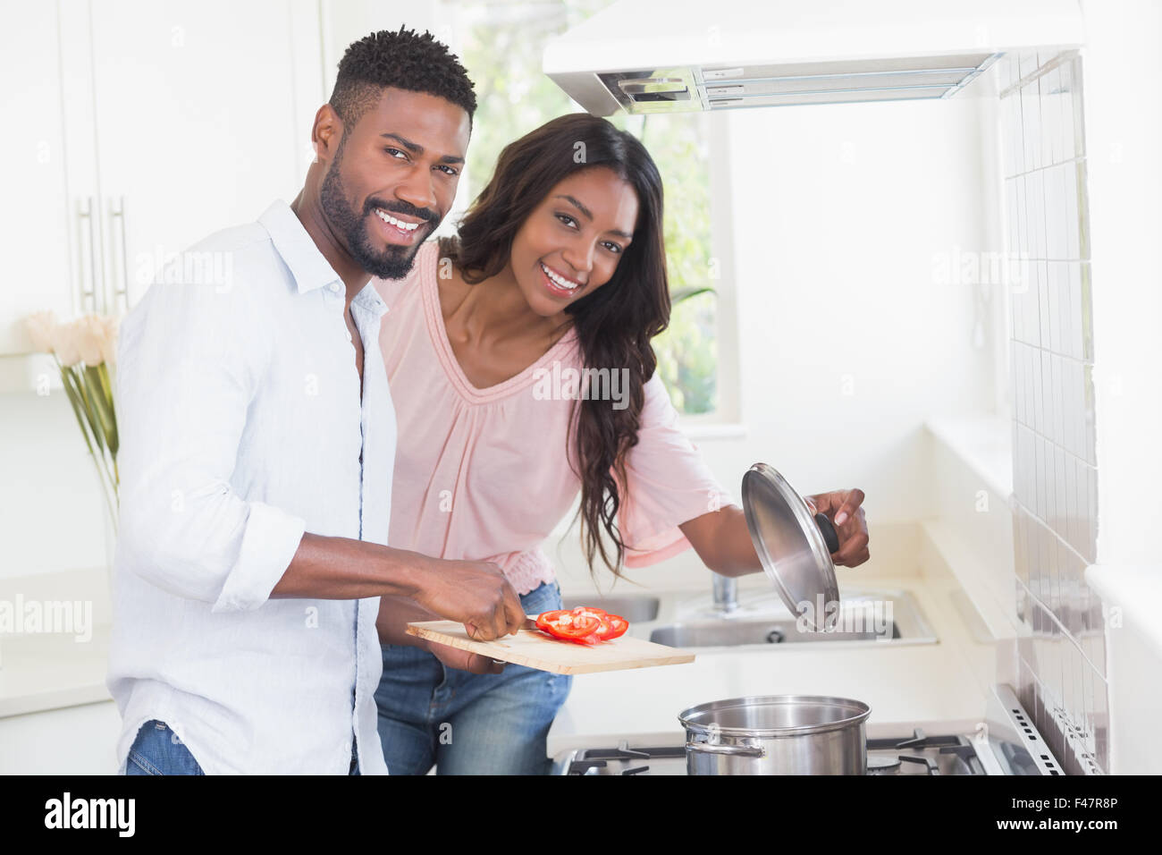 Happy couple cooking food together Stock Photo - Alamy