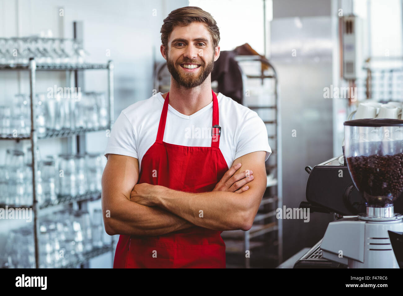 Handsome barista smiling at the camera Stock Photo - Alamy