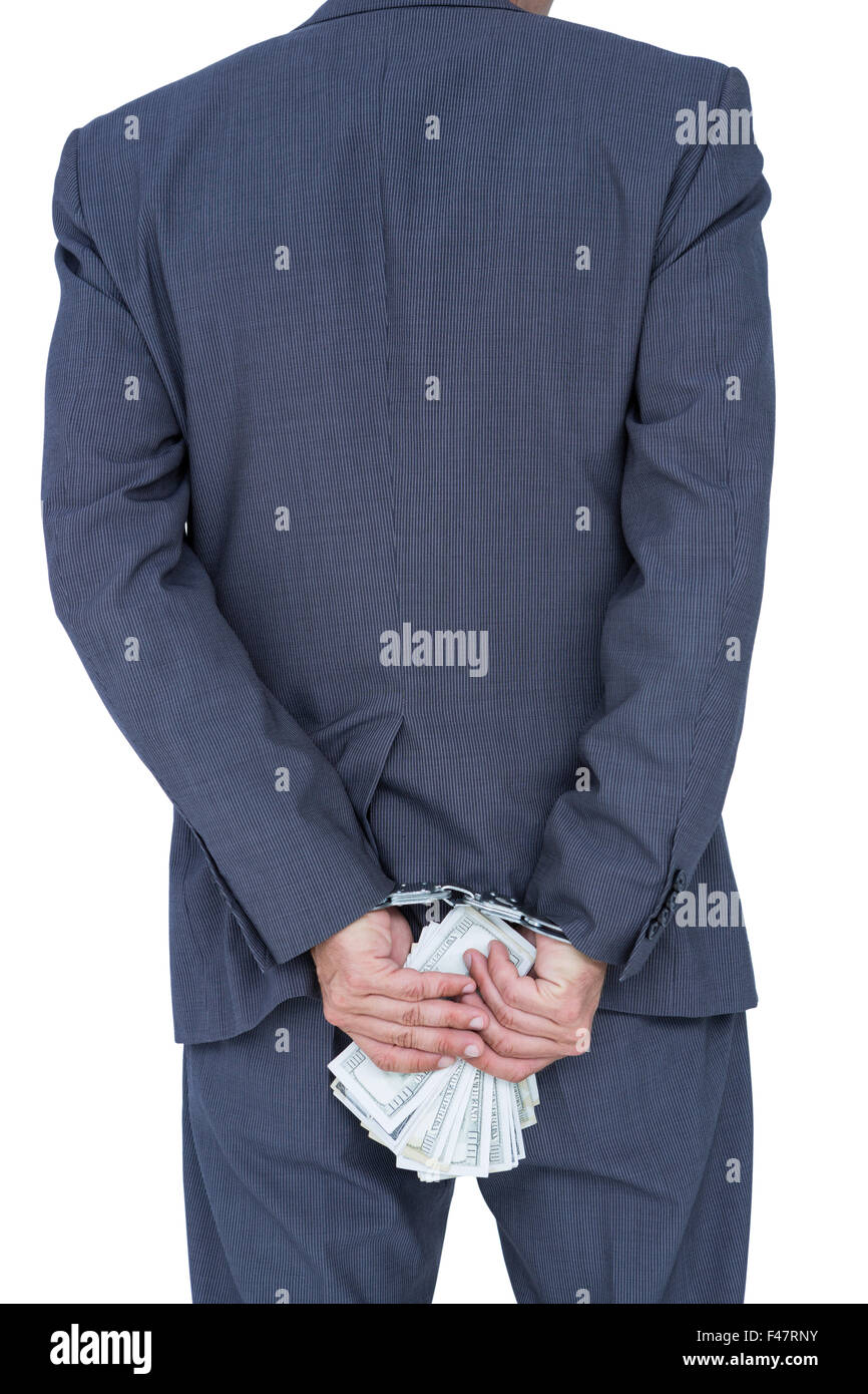 businessman in handcuffs holding bribe Stock Photo - Alamy