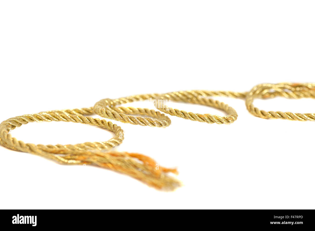 Golden rope isolated on white background Stock Photo - Alamy