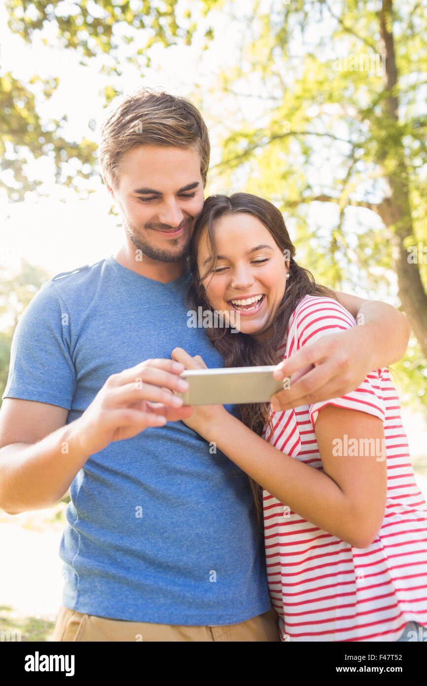 Cute couple holding smartphone green hi-res stock photography and ...