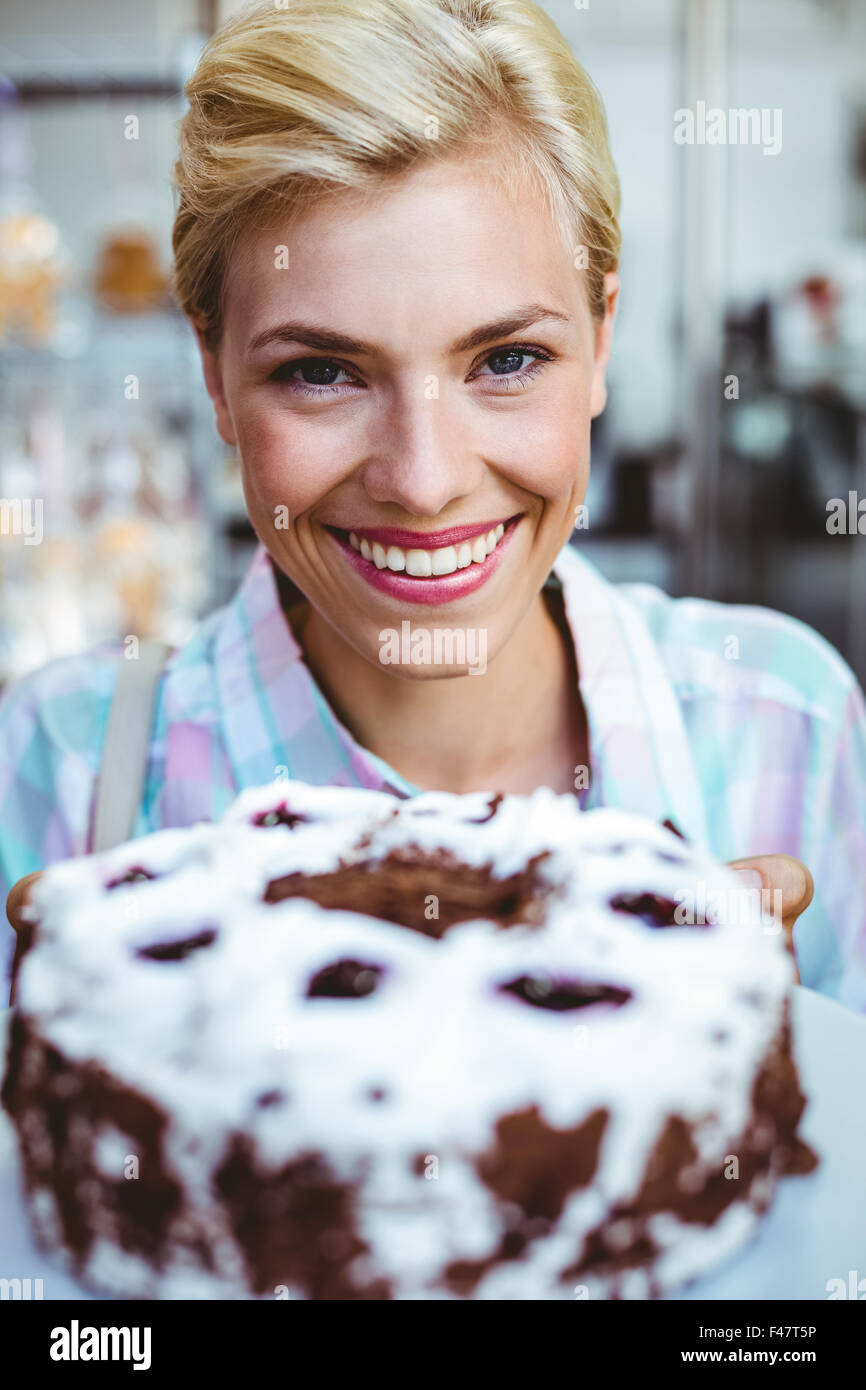 Pretty woman looking at a chocolate cake Stock Photo - Alamy