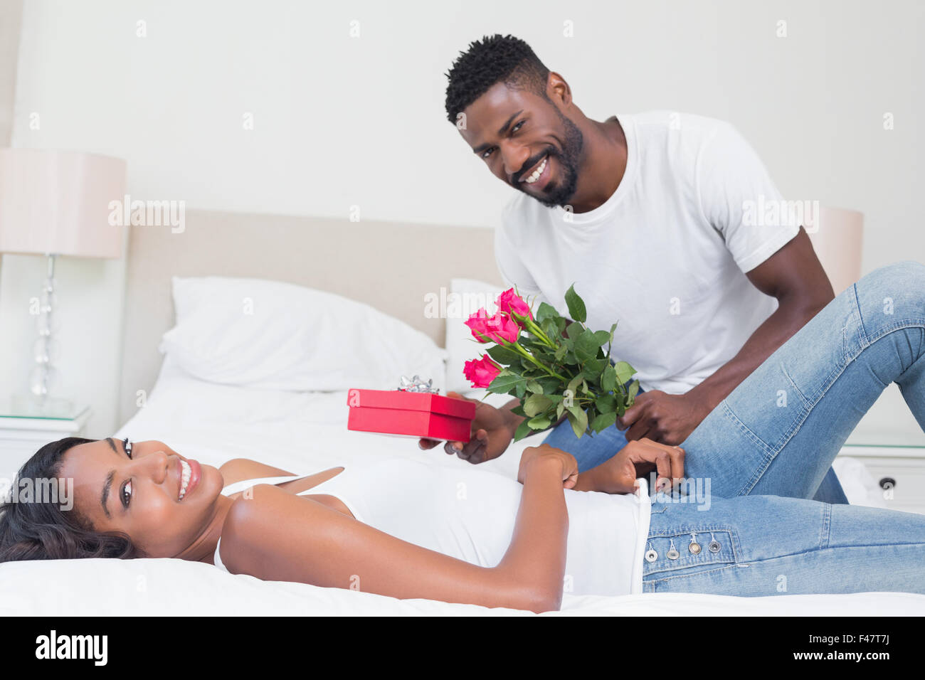 Romantic man giving roses to partner Stock Photo - Alamy